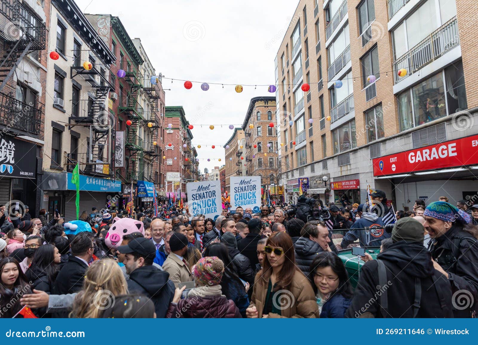 Group of People Standing on a Busy Street with a Multitude of Flags and ...