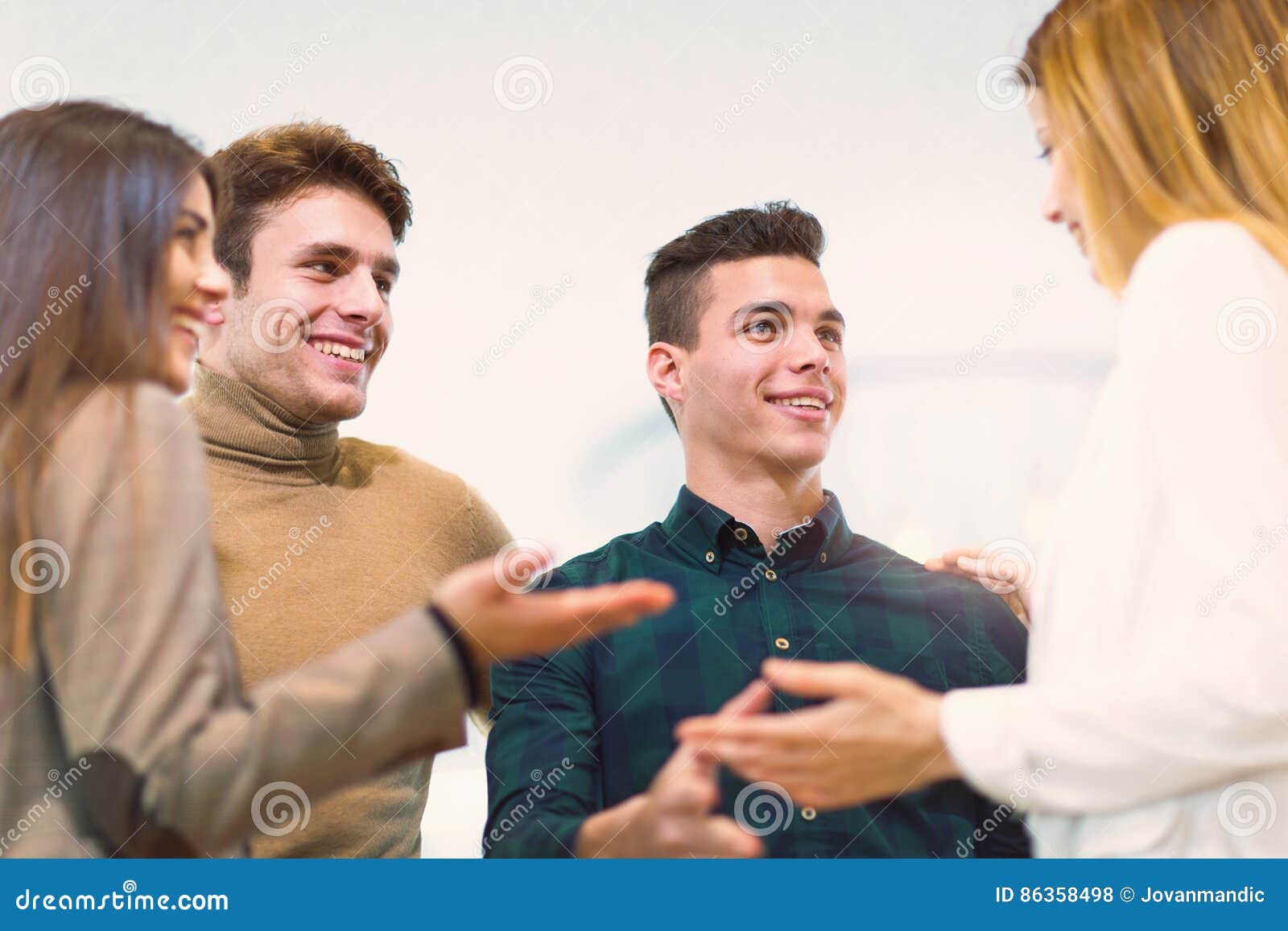 Group of People Standing Close To Each Other while and Gesturing Stock ...