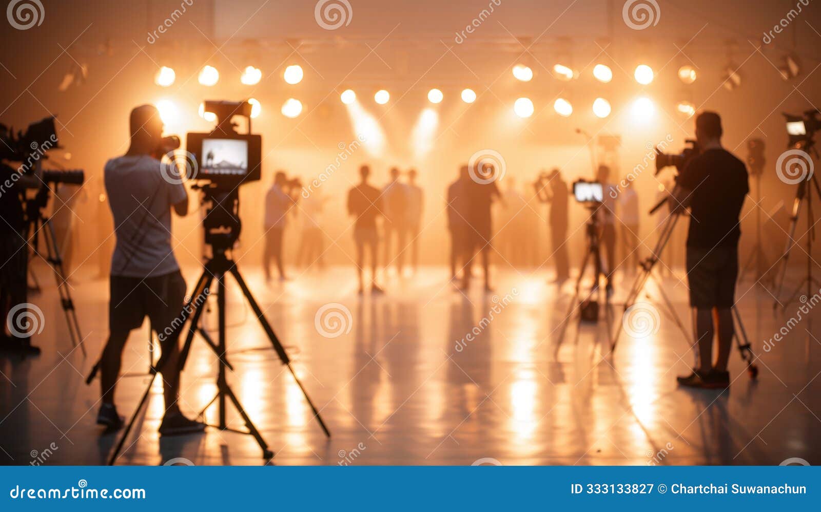 A Group of People are Standing in a Large Room with a Camera Crew ...