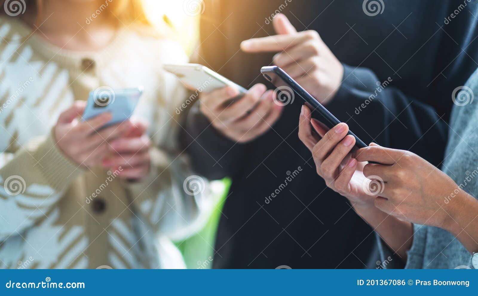 Group of People Using and Looking at Mobile Phone Together Stock Photo ...