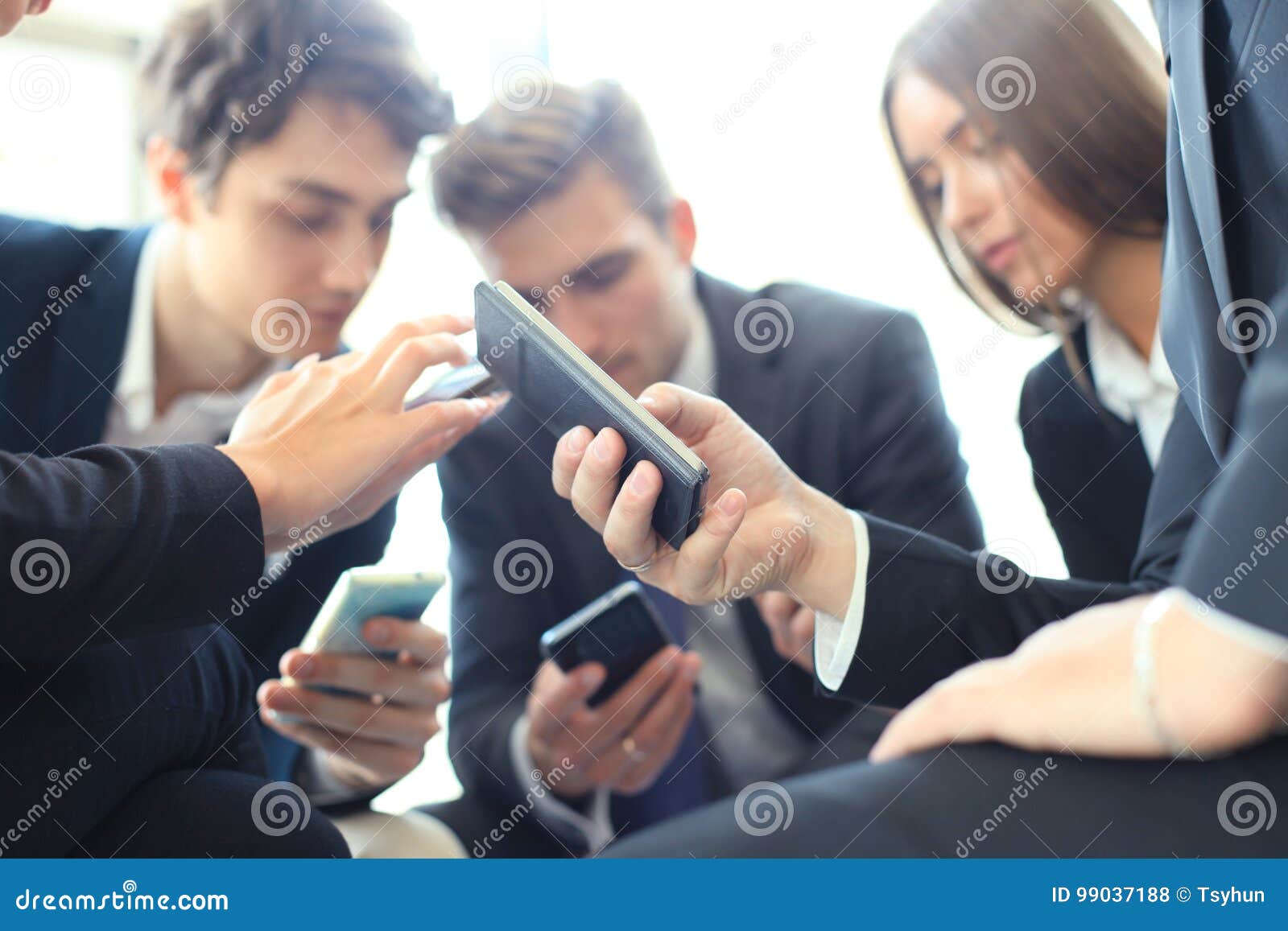 Group of People Using Smart Phones Sitting at the Meeting, Close Up on ...