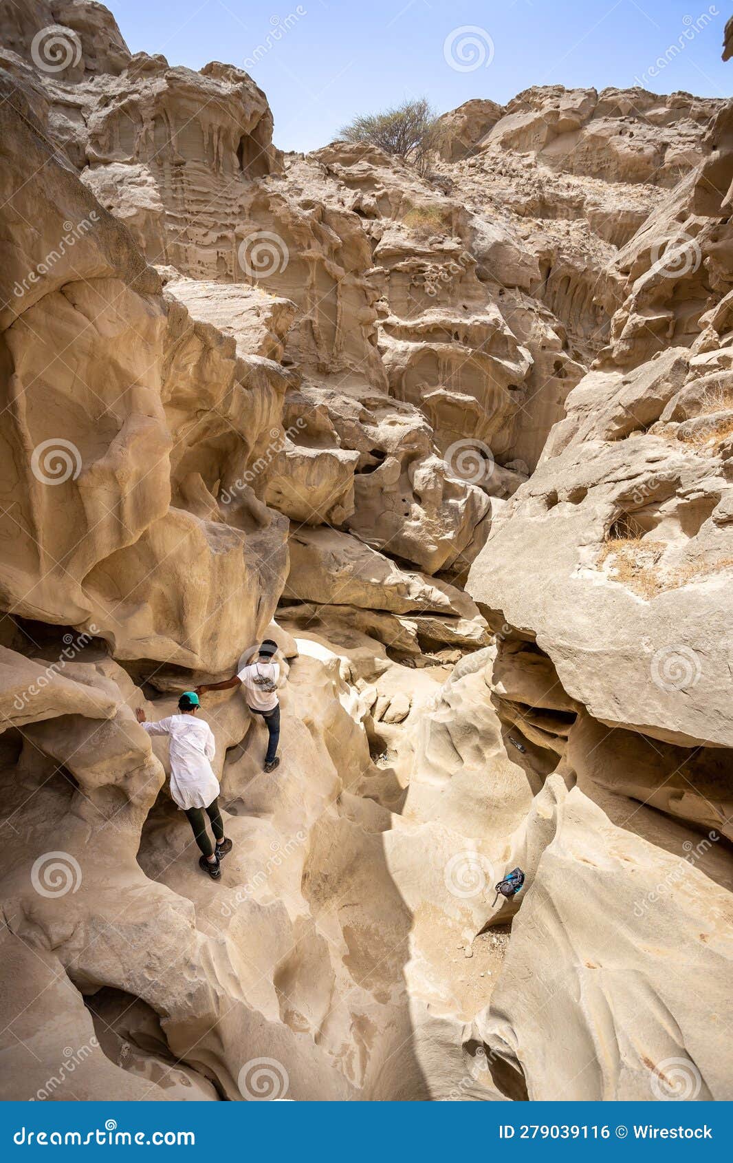 Group of People Walking Down a Rocky Canyon Path in Qeshm, Iran ...