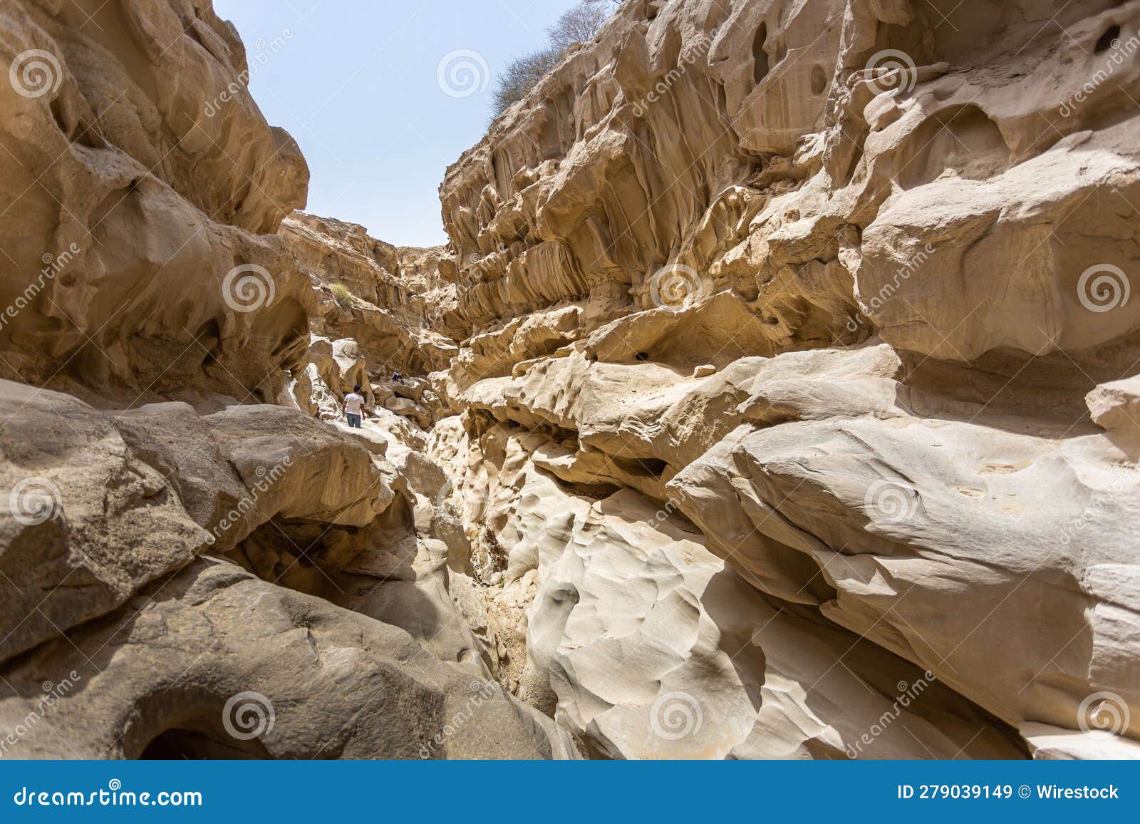 Group of People Walking Down a Rocky Canyon Path in Qeshm, Iran ...