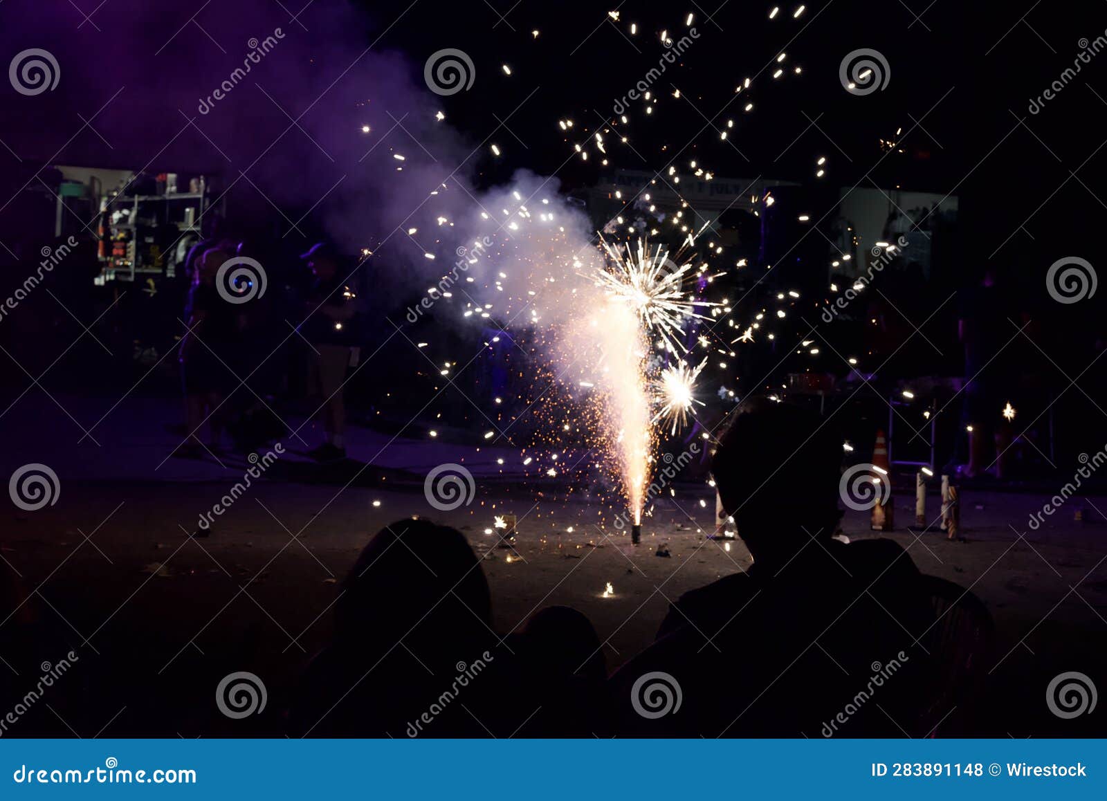 Group of People Watching a Dazzling Display of Fireworks Light Up the ...