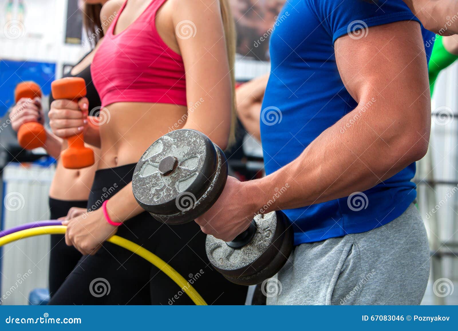 Group of People Working with Dumbbells and Hoop at Gym. Stock Photo ...
