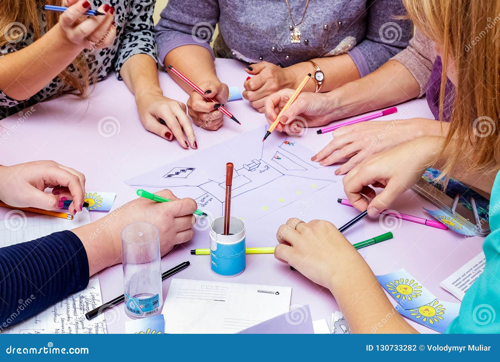 A Group of People is Working on a Joint Project. Performing a Sketch ...