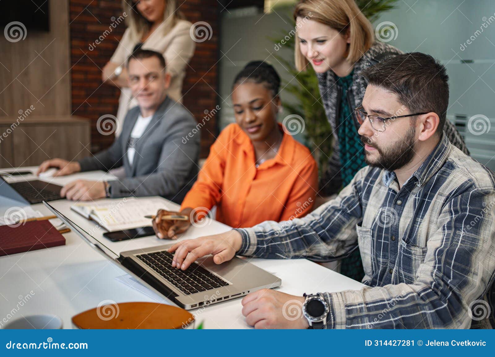 Group of People Working on Laptops at Table Stock Image - Image of ...