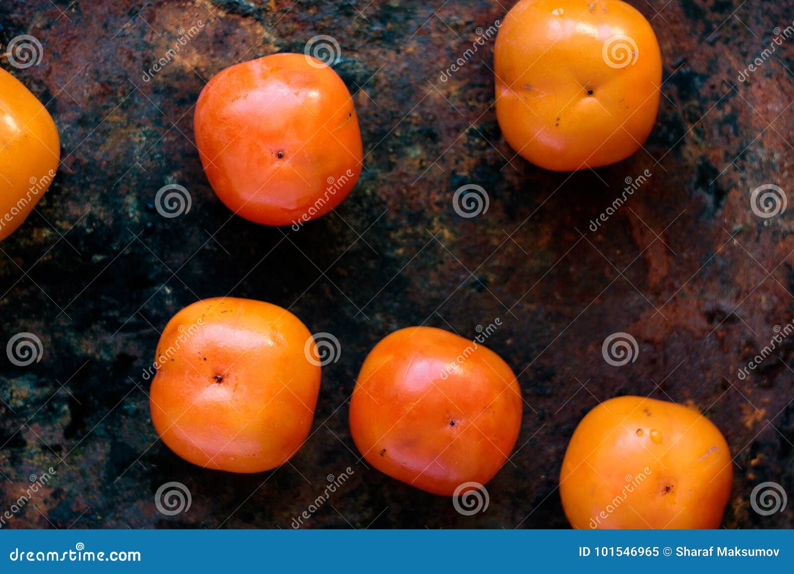 Group of Persimmons on Black Rustic Surface. Stock Image - Image of ...