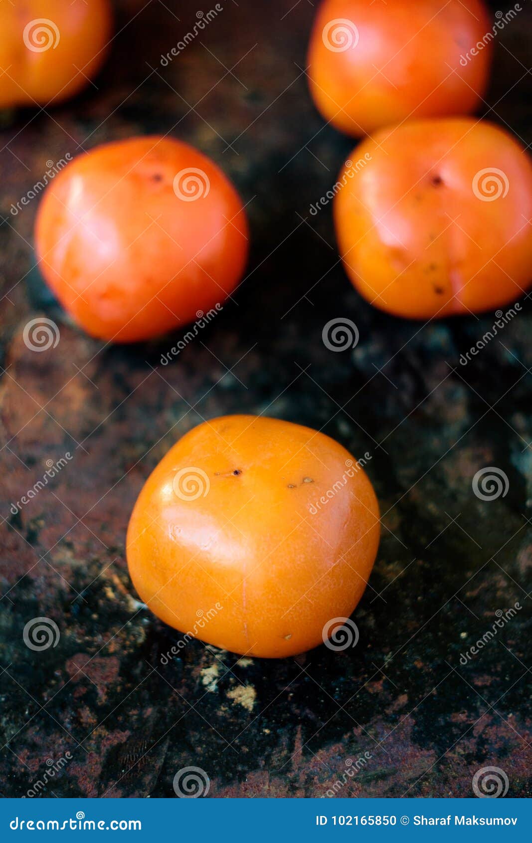 Group of Persimmons on Black Rustic Surface. Stock Photo - Image of ...