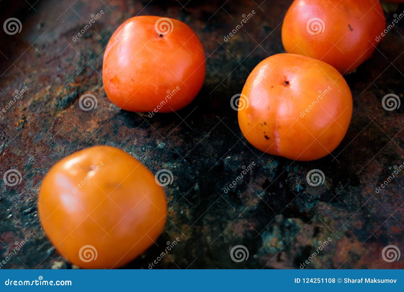 Group of Persimmons on Black Rustic Surface. Stock Photo - Image of ...