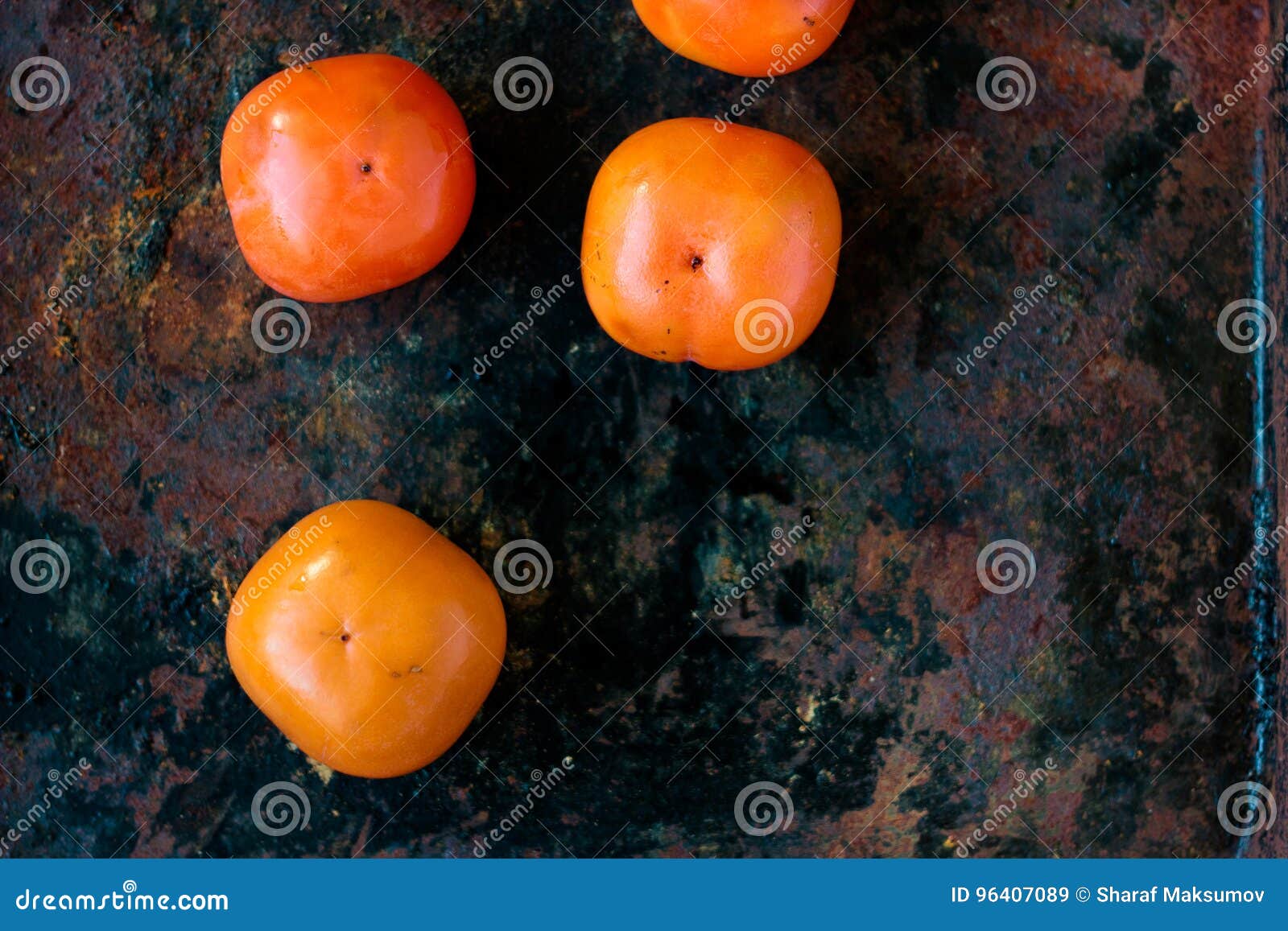 Group of Persimmons on Black Rustic Surface. Stock Image - Image of ...