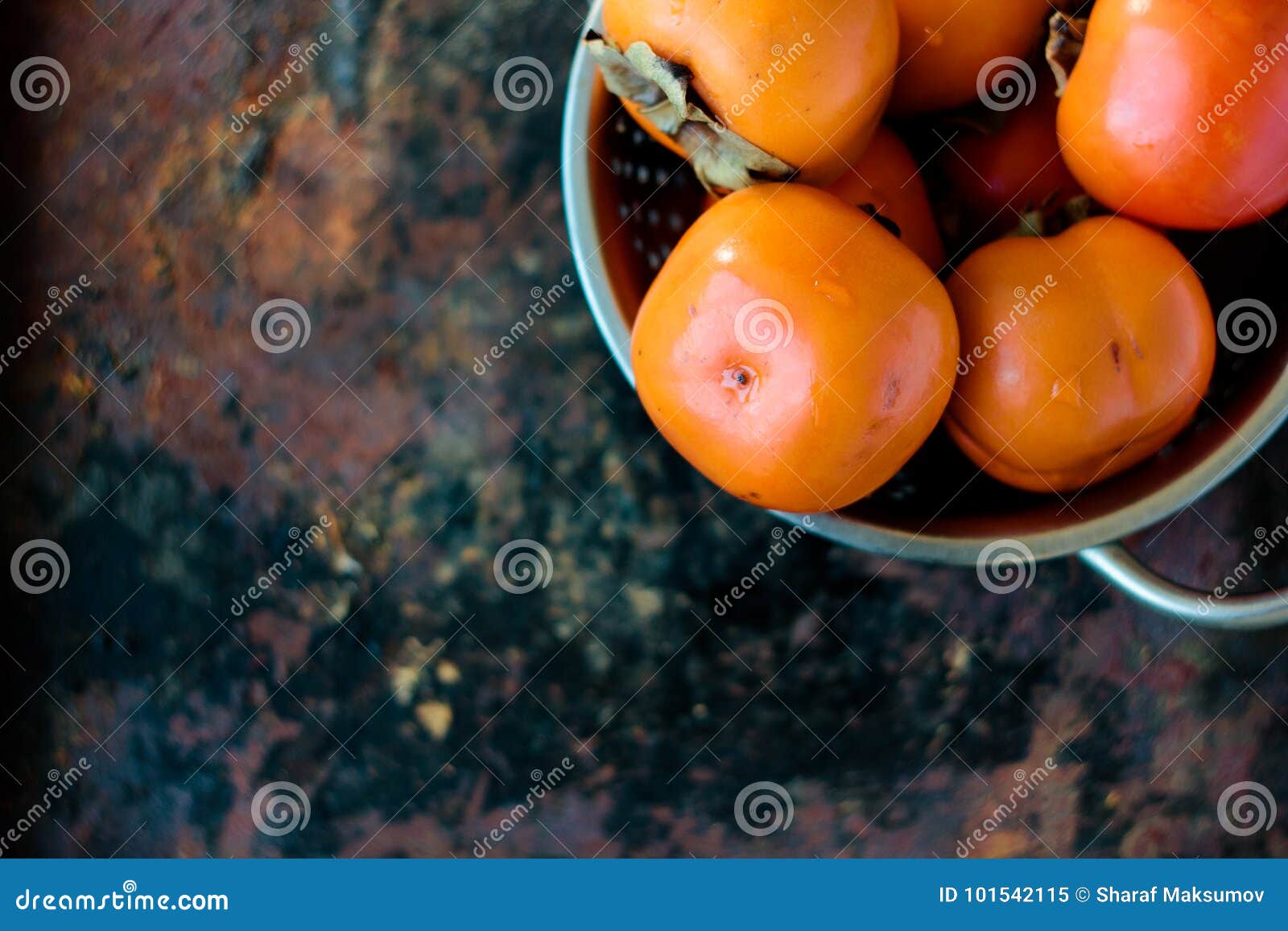 Group of Persimmons in Metal Collander Over Rustic Surface. Stock Image ...