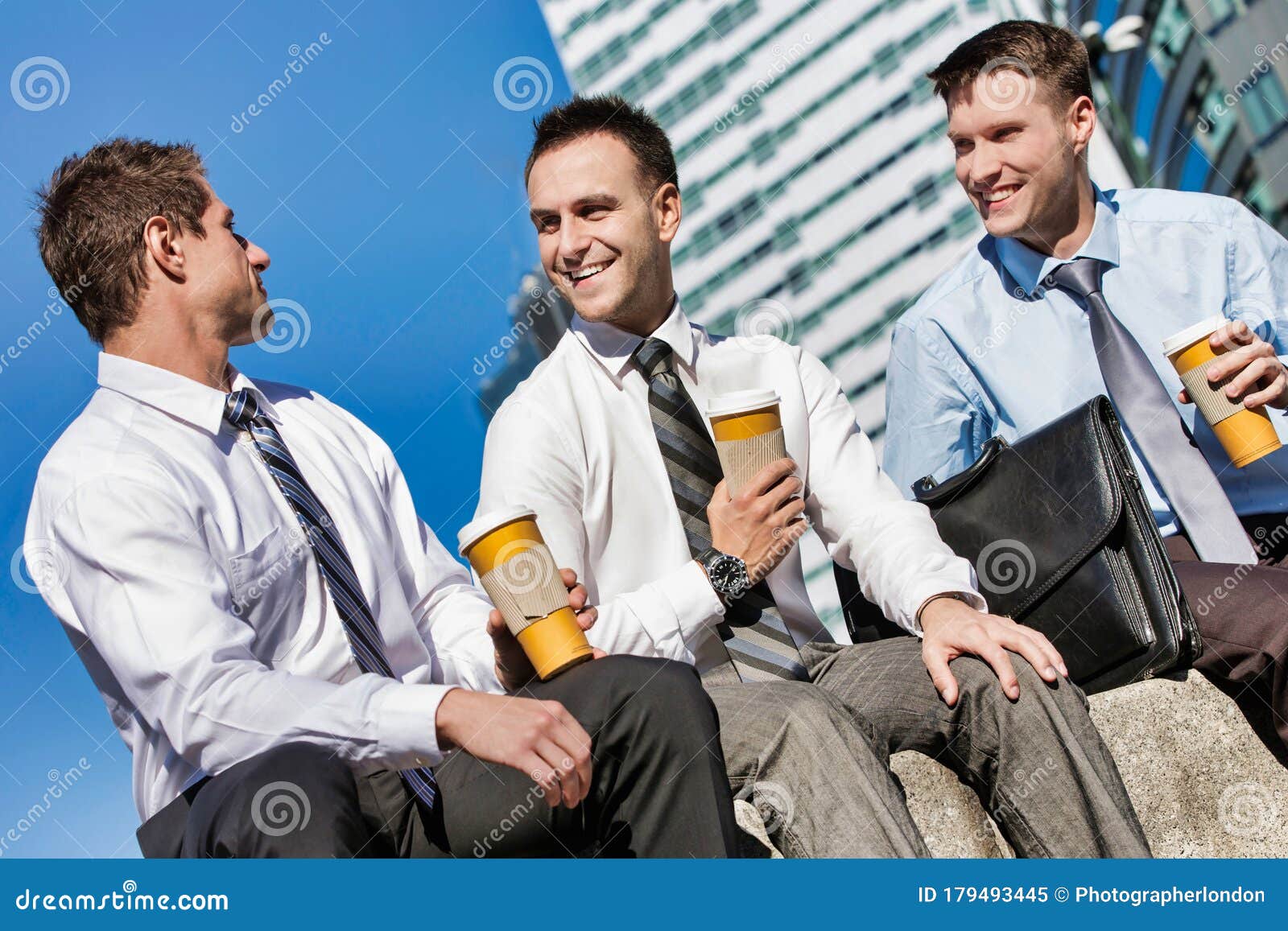 Group of Colleagues Sitting and Talking while Drinking Coffee after ...
