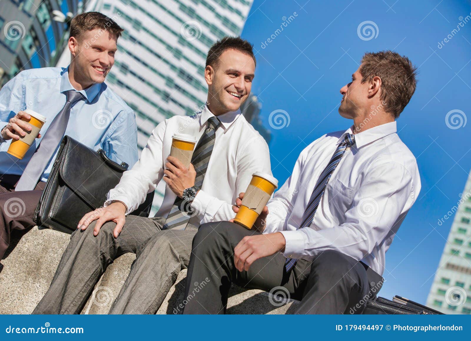 Group of Colleagues Sitting and Talking while Drinking Coffee after ...