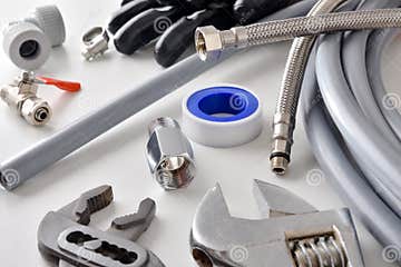 Group of Plumbing Materials and Tools on White Workbench Elevated Stock ...