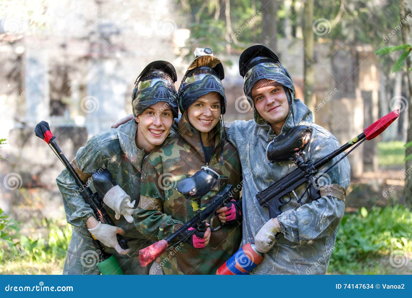 Group Portrait of Three Smiling Paintball Players Outdoors Stock Photo ...