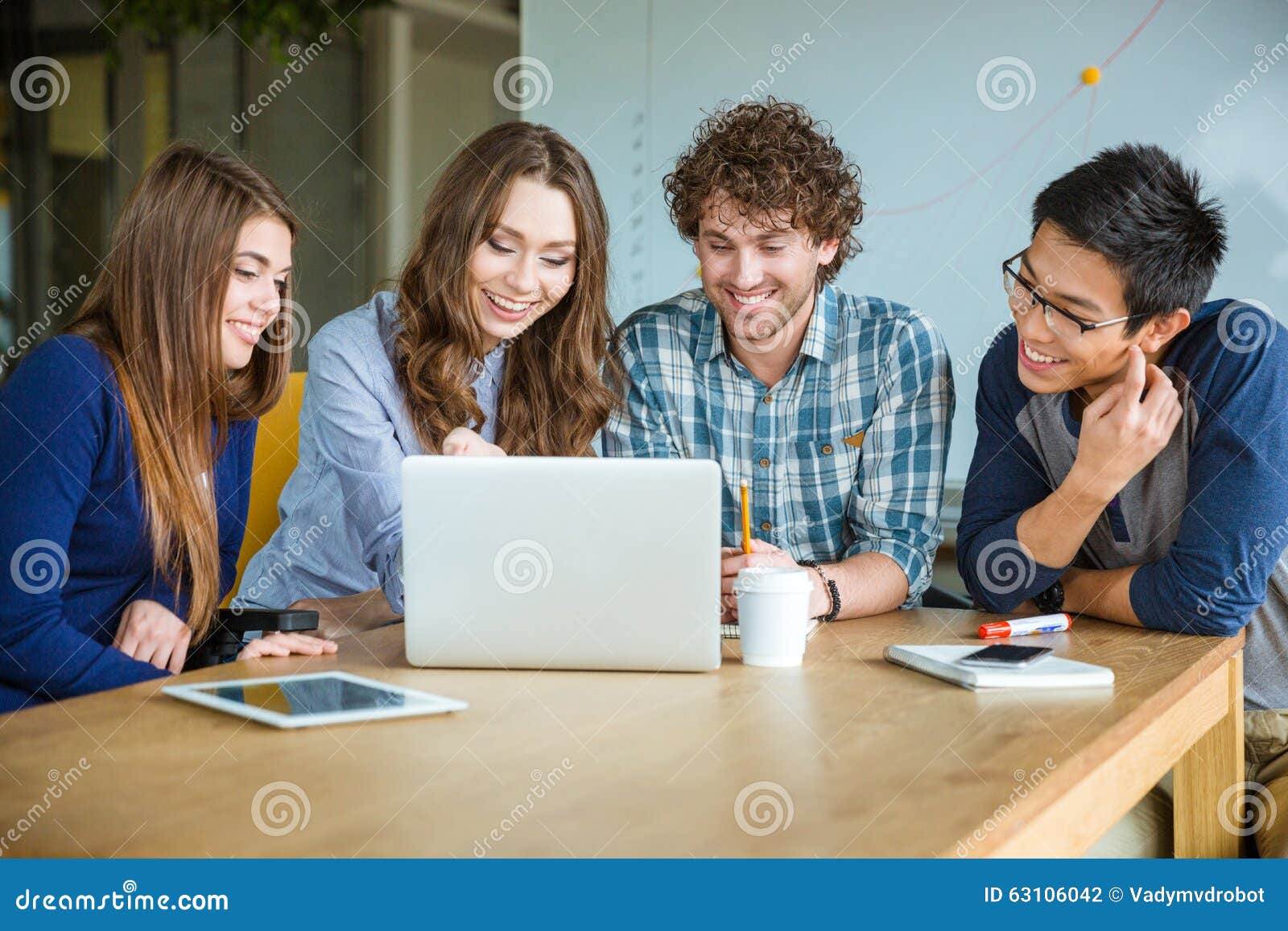 Group Of Positive Cheerful Students Doing Homework Together In ...
