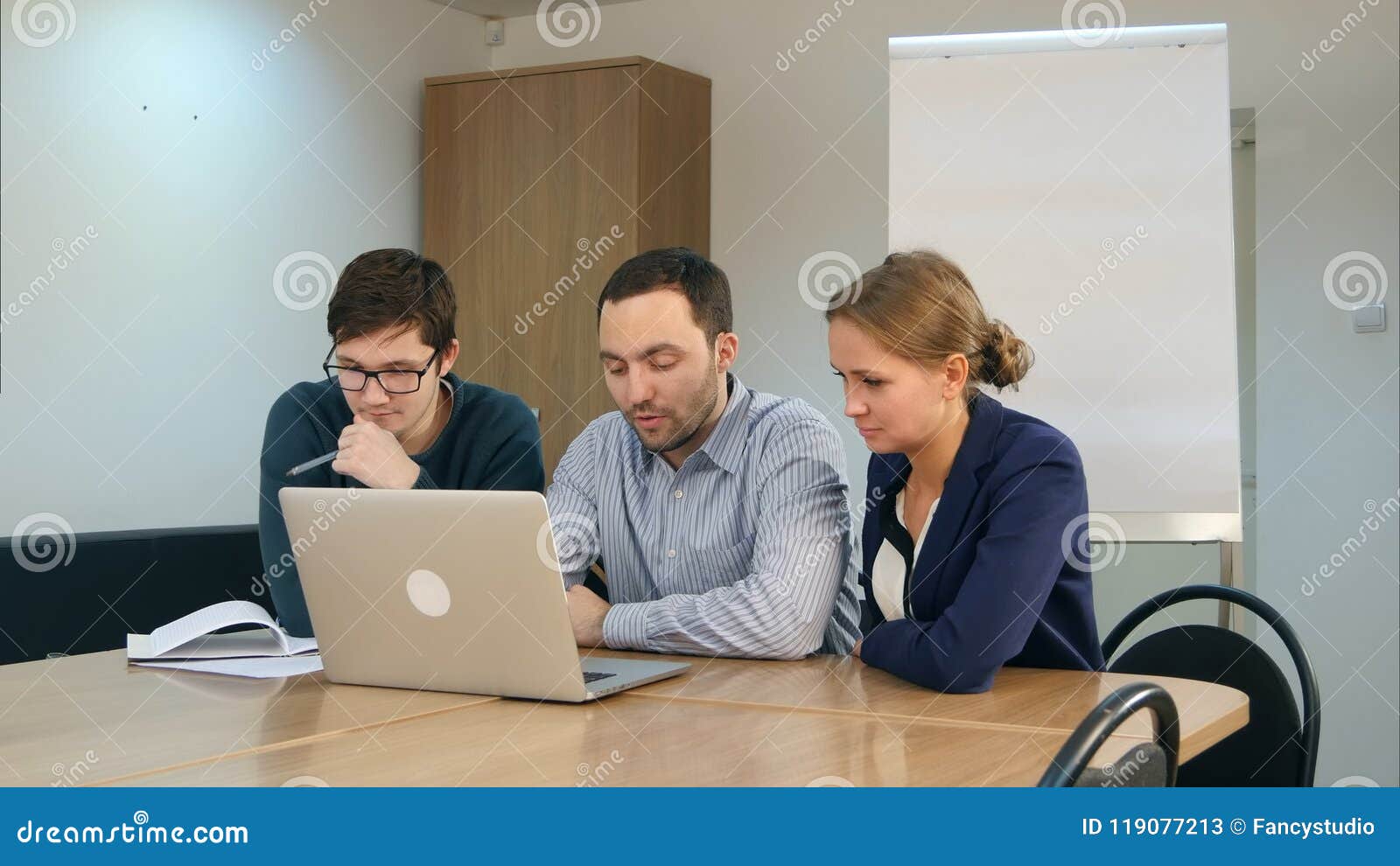 Group of Positive Cheerful Students Using Laptop and Doing Homework ...