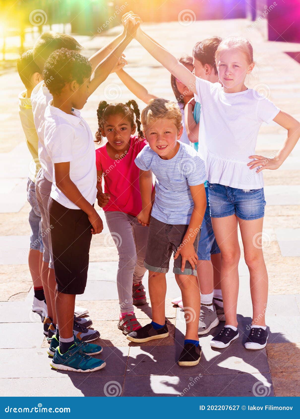 Group of Positive Children Holding Hands Up and Playing Together Stock ... Group of Positive Children Holding Hands Up and Playing Together Stock ...