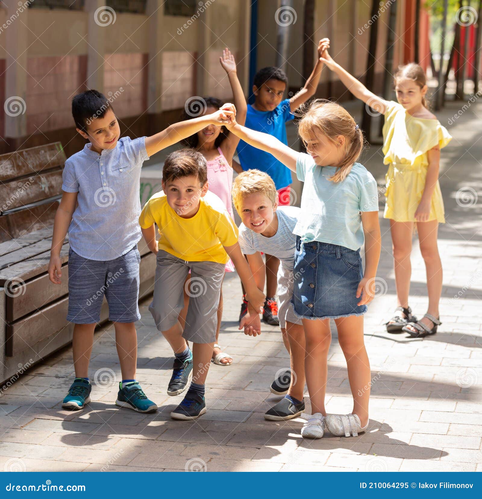 Group of Positive Schoolchildren Holding Hands Up and Playing Stock ... Group of Positive Schoolchildren Holding Hands Up and Playing Stock ...