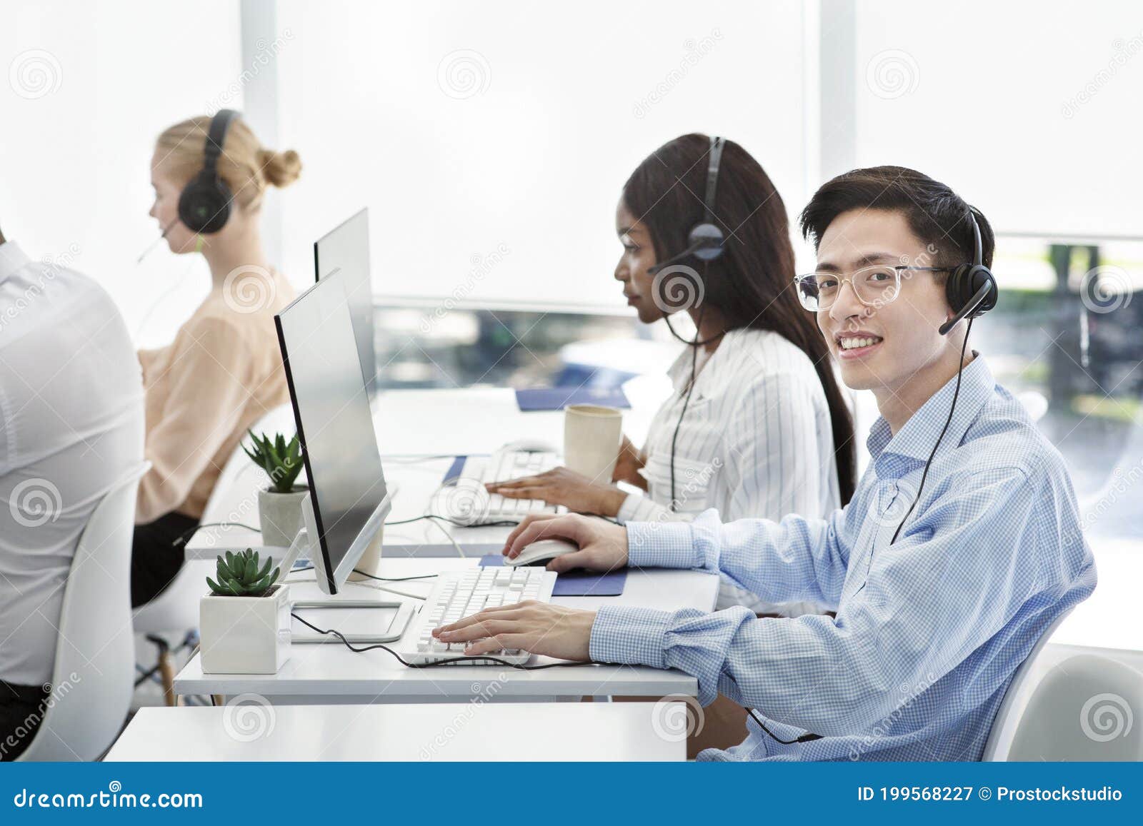 Group of Positive Technical Support Managers Working on Hotline at Call ...