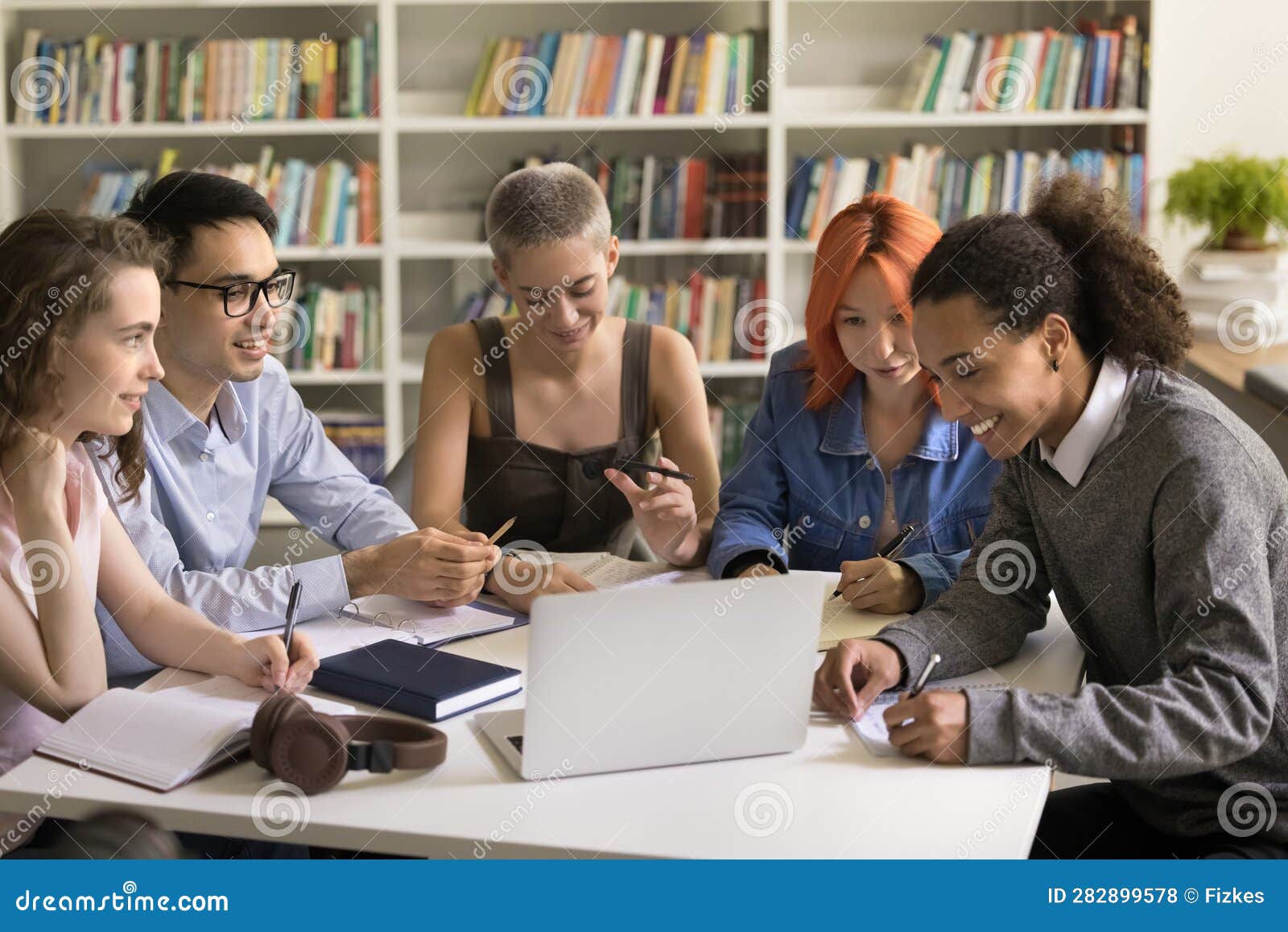 Group of Positive Young College Students Doing Homework in Library ...