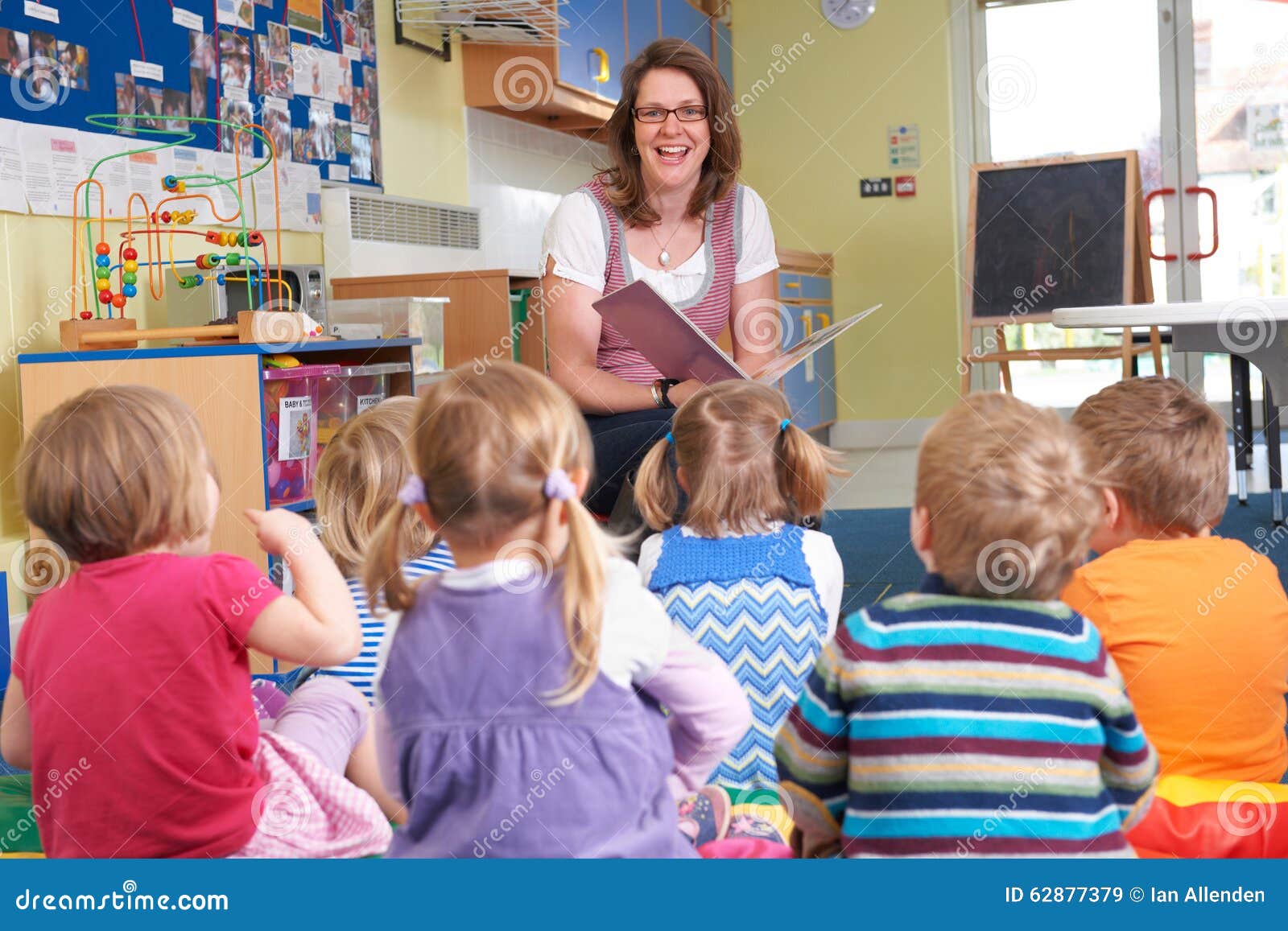 Group of Pre School Children Listening To Teacher Reading Story Stock ... Group of Pre School Children Listening To Teacher Reading Story Stock ...