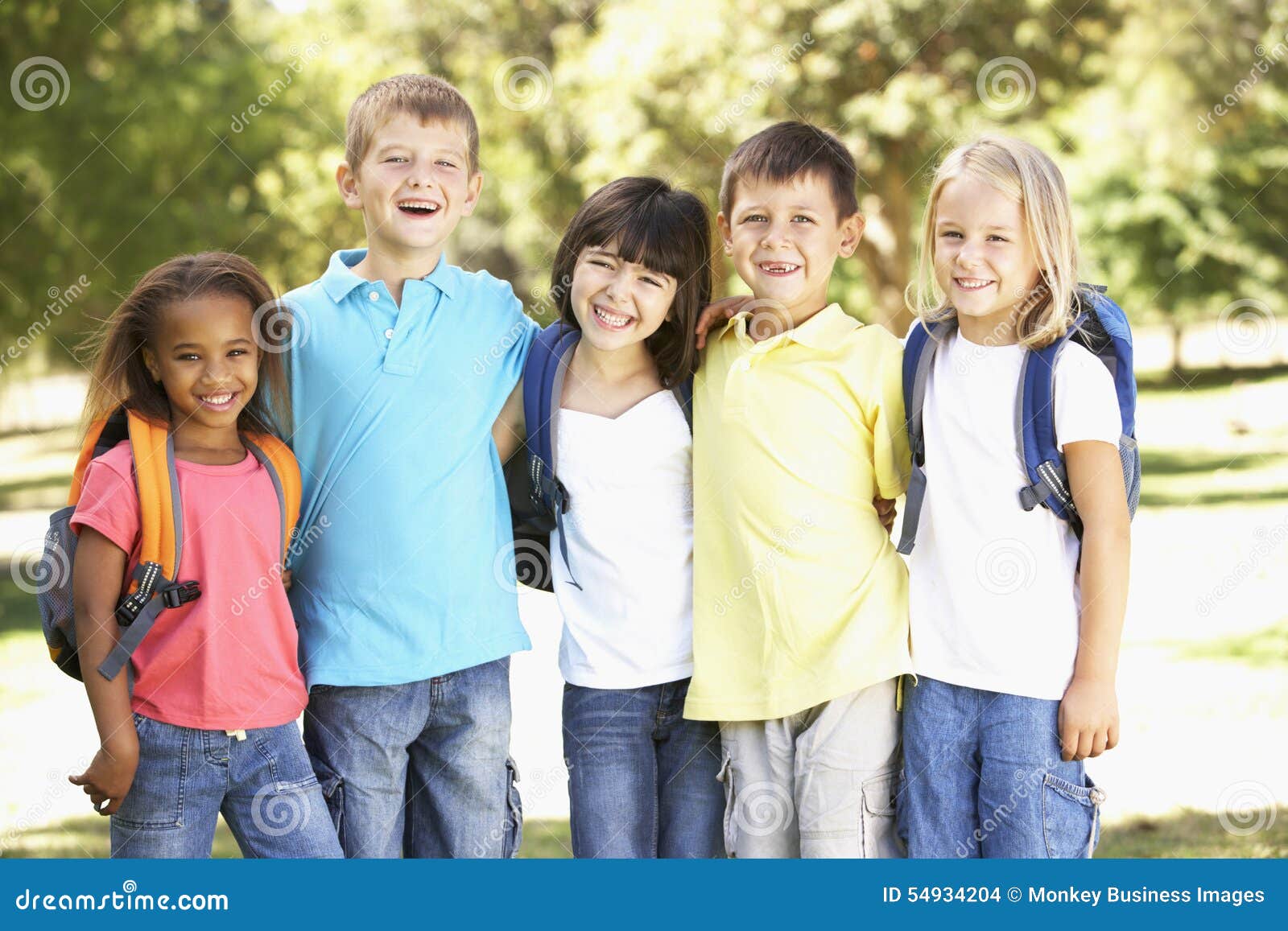 Group of Primary School Pupils Wearing Backpacks in Park Stock Photo ...