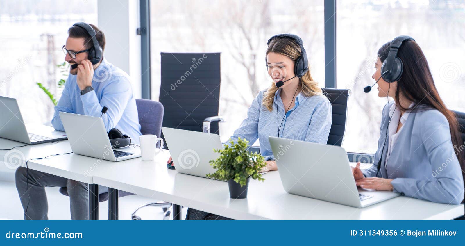 Group of Professional Help Desk Representatives Working in Call Center ...