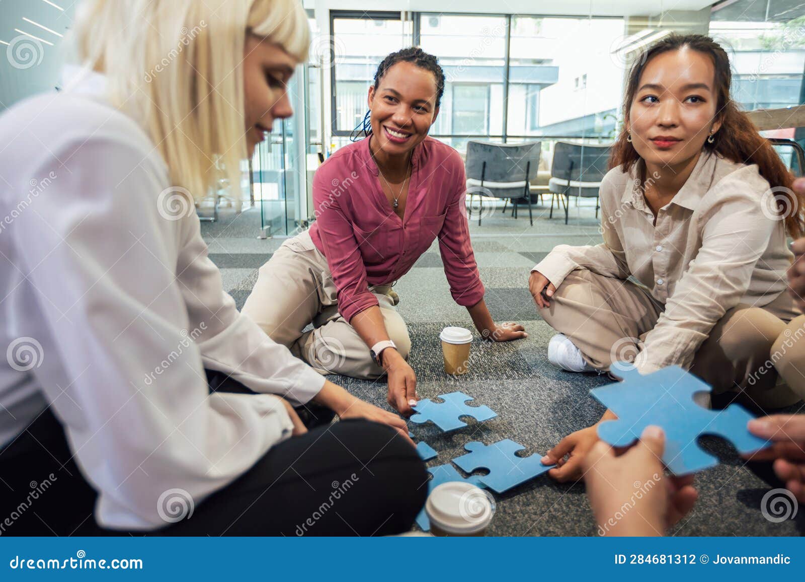 Professional People Playing Puzzle on the Floor of the Office.Team ...
