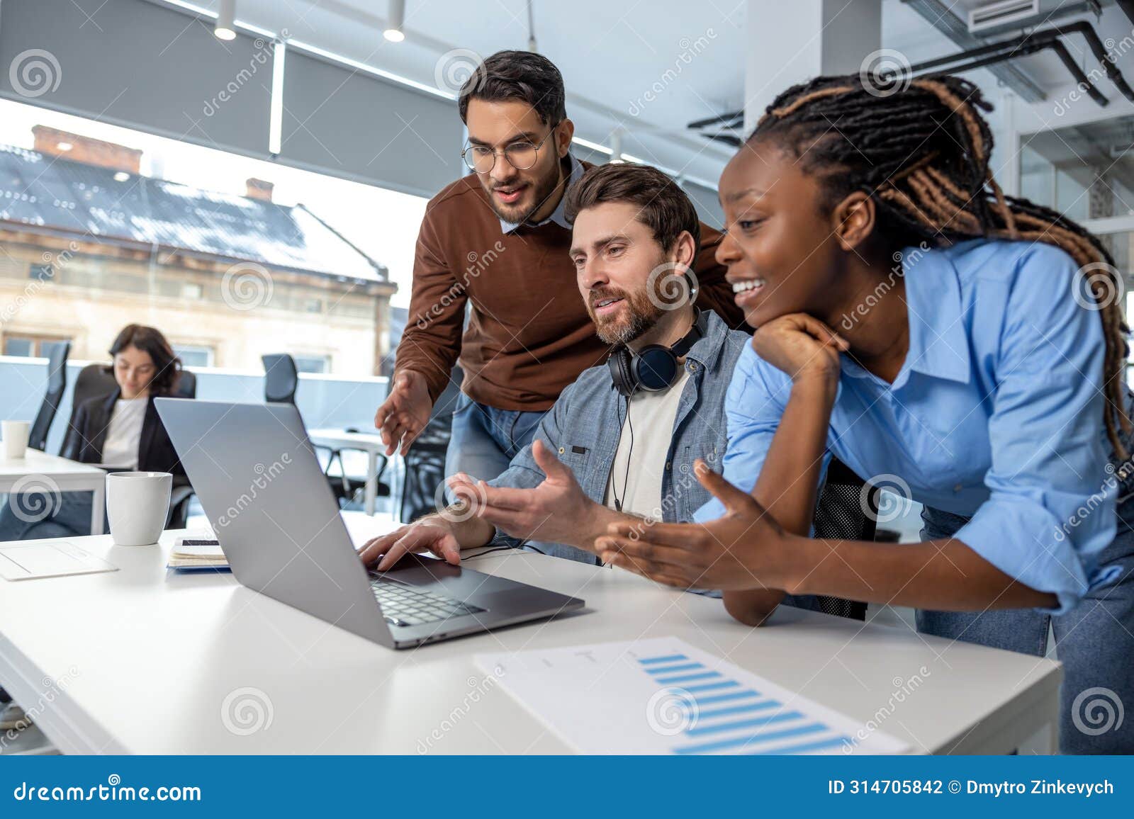 Group of Professionals Collaborating and Using Laptop in Coworking ...