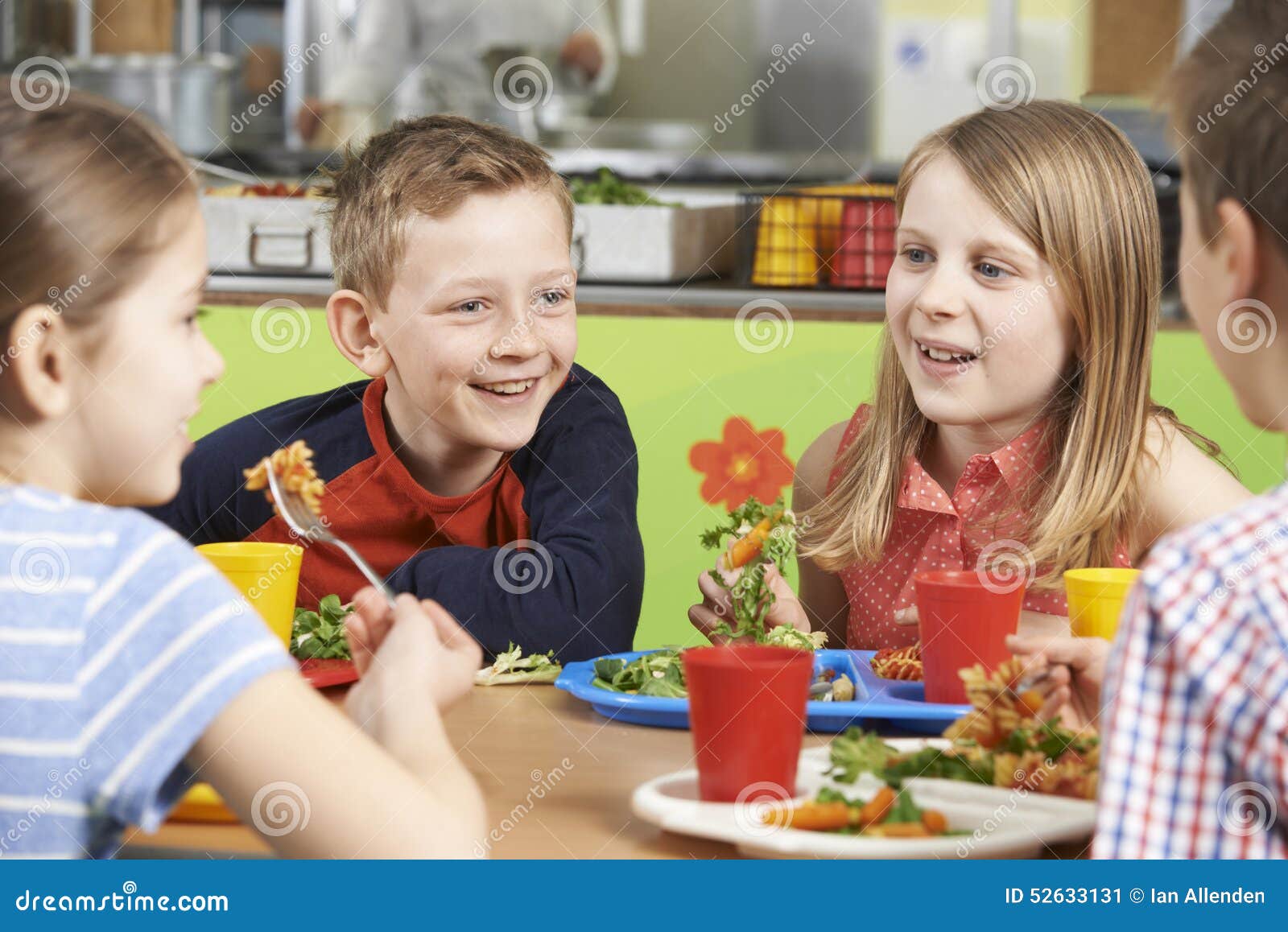 Group Of Pupils Sitting At Table In School Cafeteria Eating Lunc Stock ...