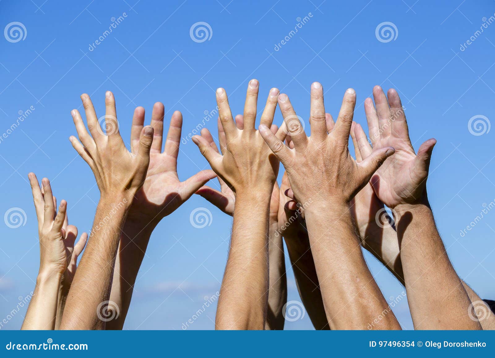 Group Raising Hands Against Blue Sky Background Stock Photo - Image of ...