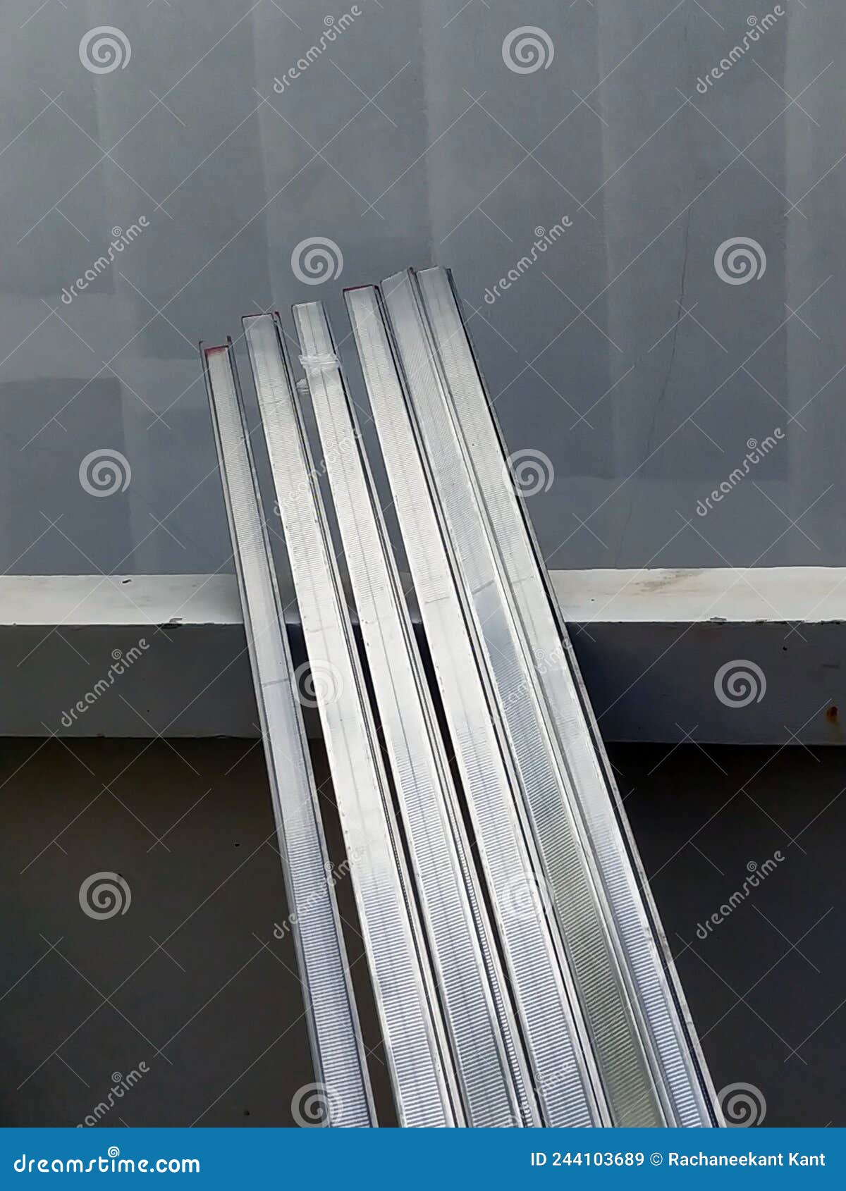 A Group of Rebar Leans Against the Edge of a Cement Wall. Stock Image ...