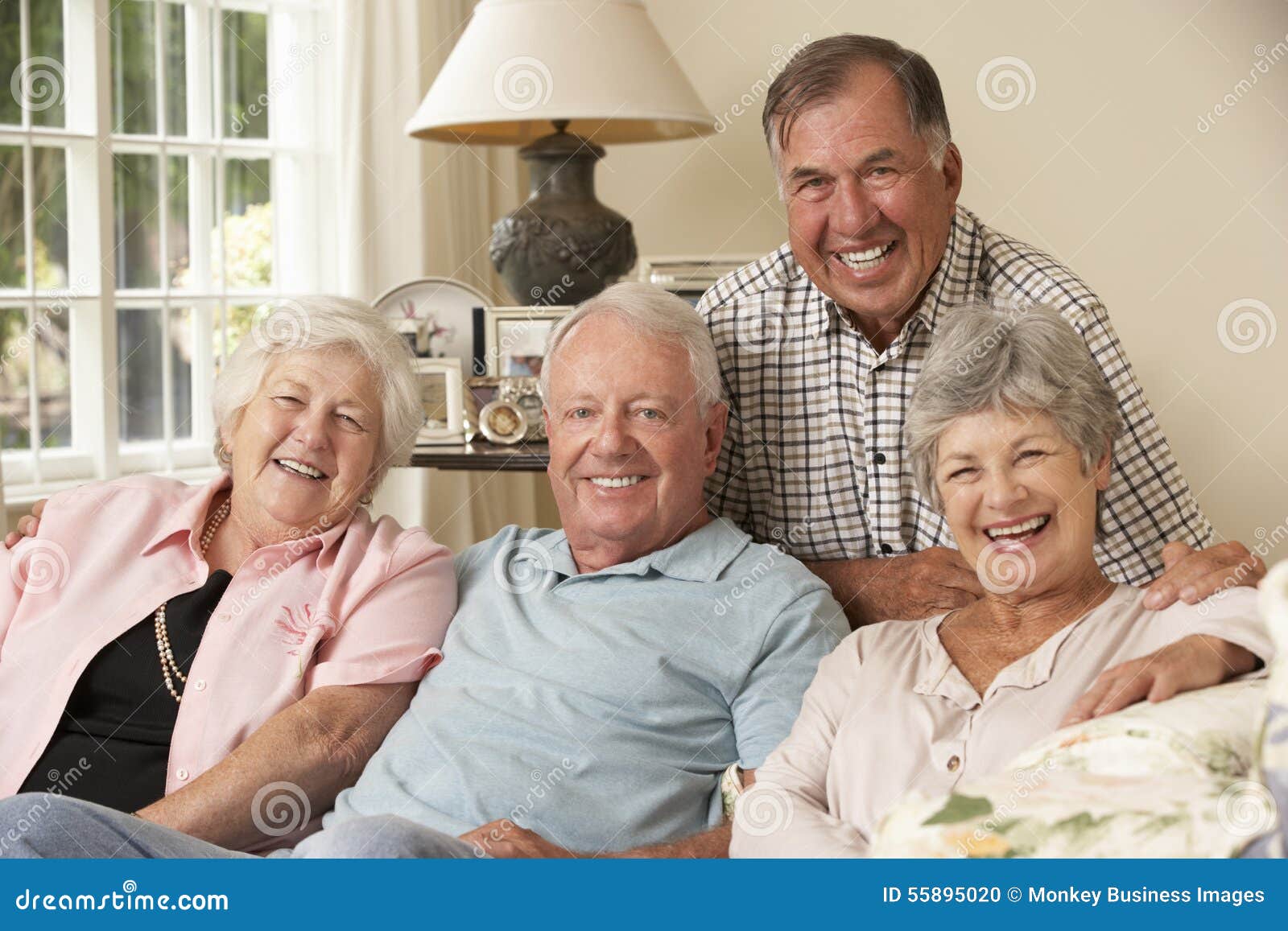 Group of Retired Friends Sitting on Sofa at Home Together Stock Photo ...