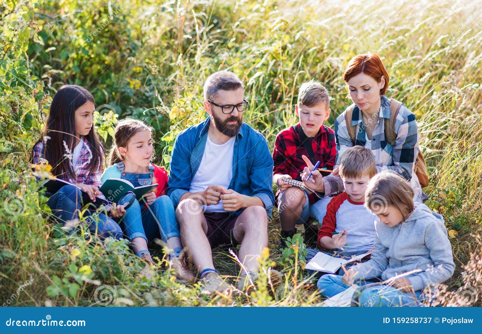 Group of School Children with Teacher on Field Trip in Nature. Stock ...
