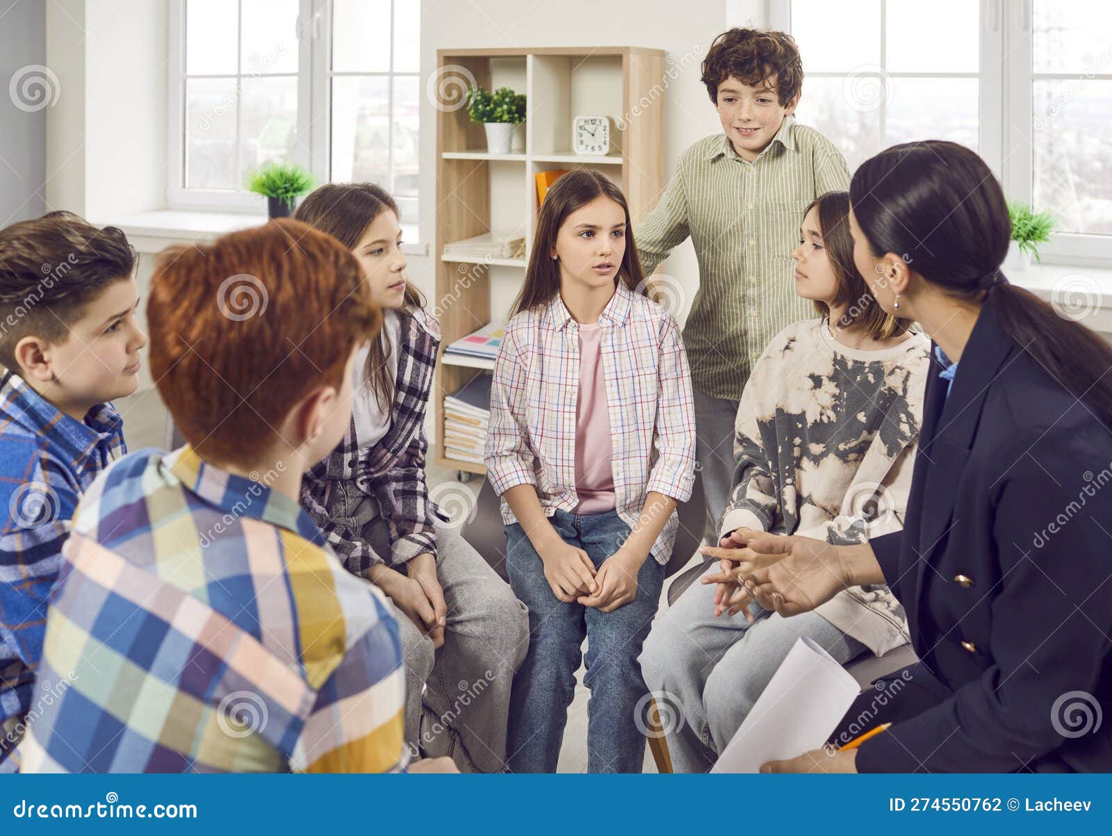 Group of School Children Together with Their Teacher Discussing ...