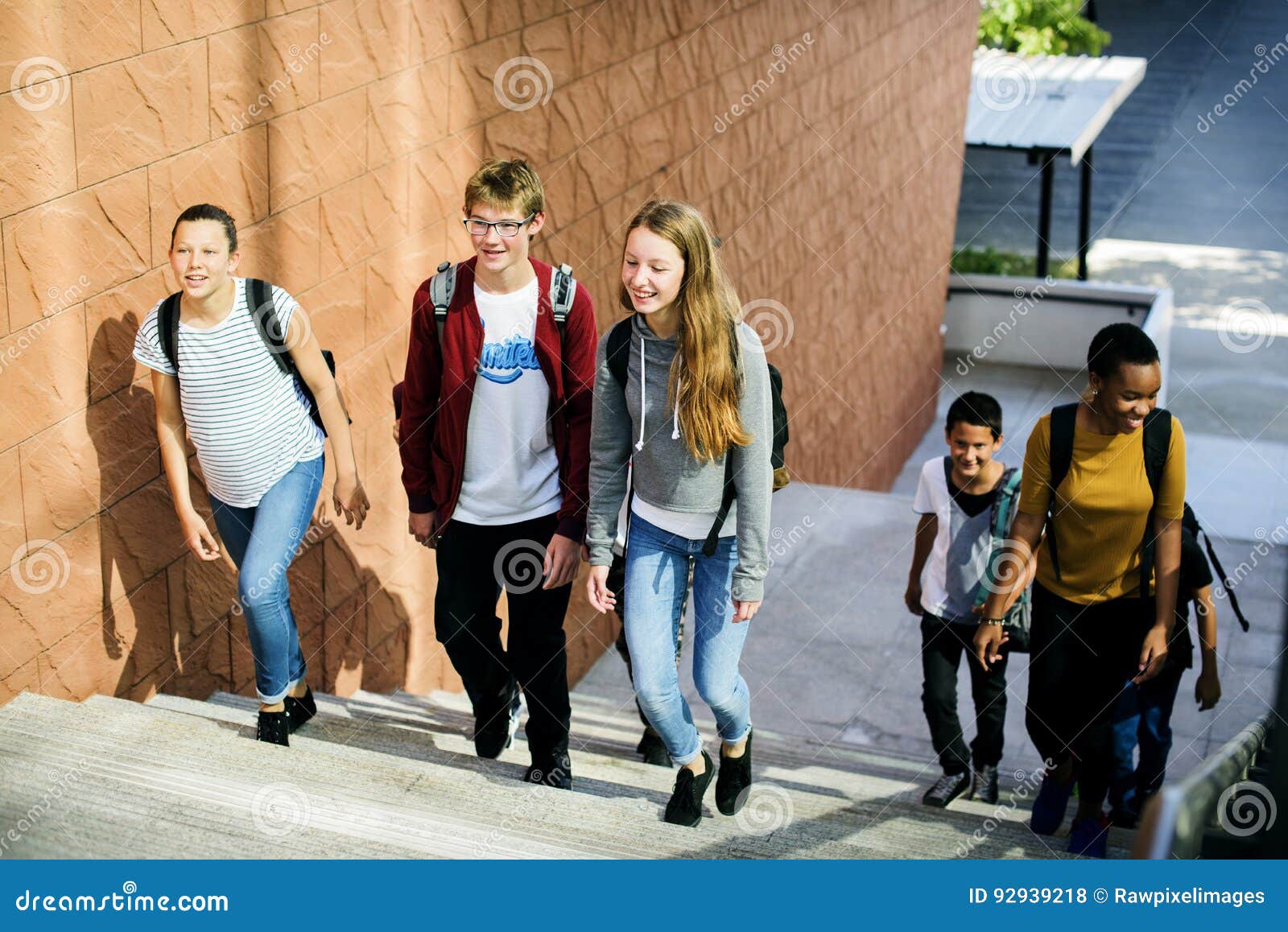 Group of School Friends Walking Down Staircase Stock Photo - Image of ...