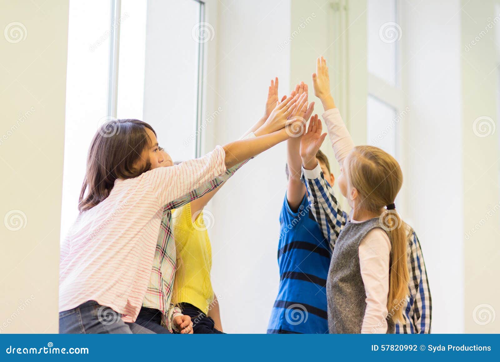 Group Of School Kids Making High Five Gesture Stock Photo ...