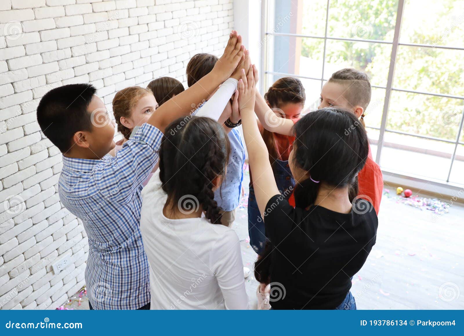Group of School Kids Stacking Hands in Classroom Education Concept ...