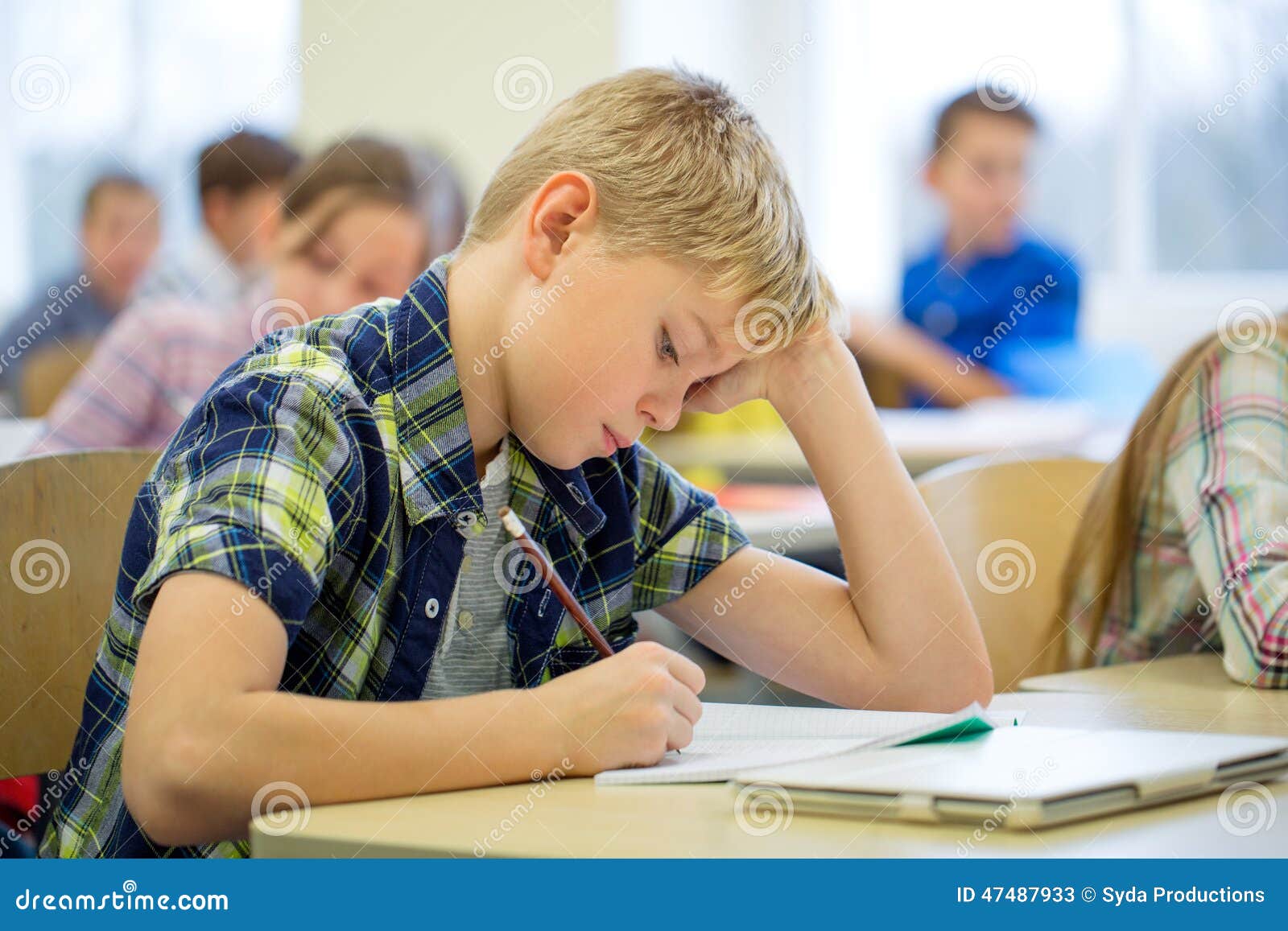 Group Of School Kids Writing Test In Classroom Royalty-Free Stock Photo ...