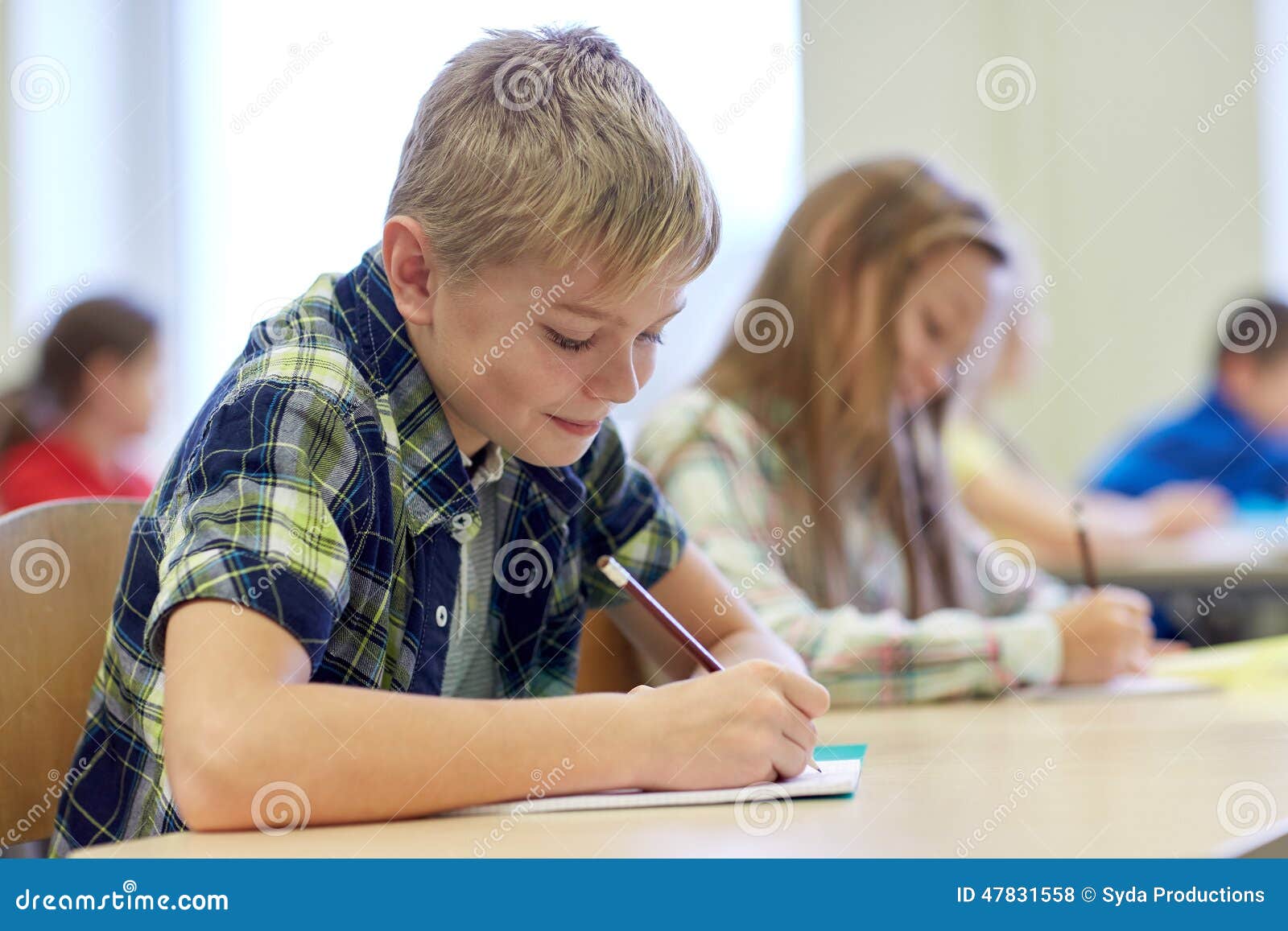 Group of School Kids Writing Test in Classroom Stock Photo - Image of ...