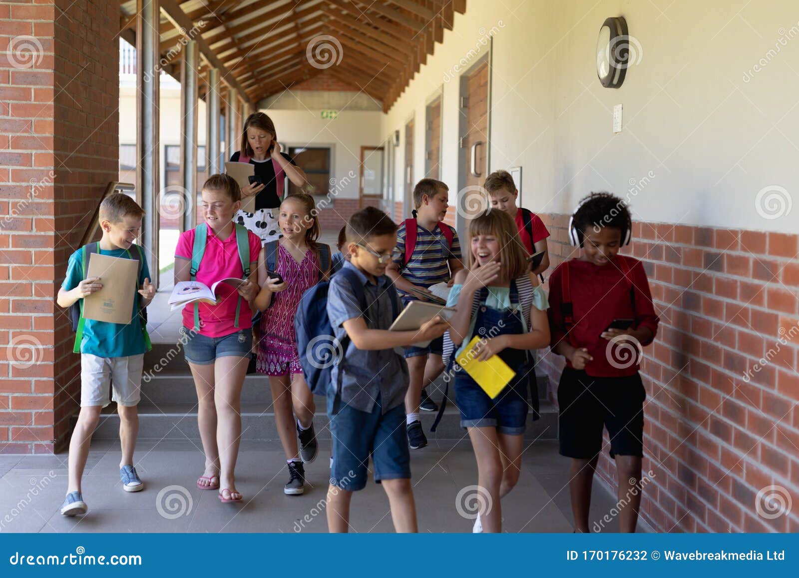 Group of School Pupils Walking in an Outdoor Corridor at Elementary ...