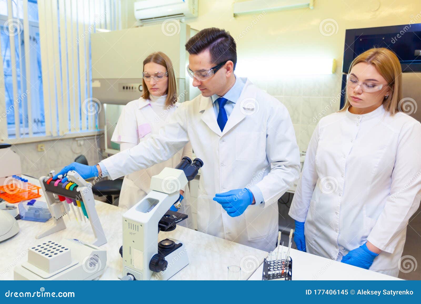 A Group of Scientists Conducts Research in a Scientific Laboratory ...