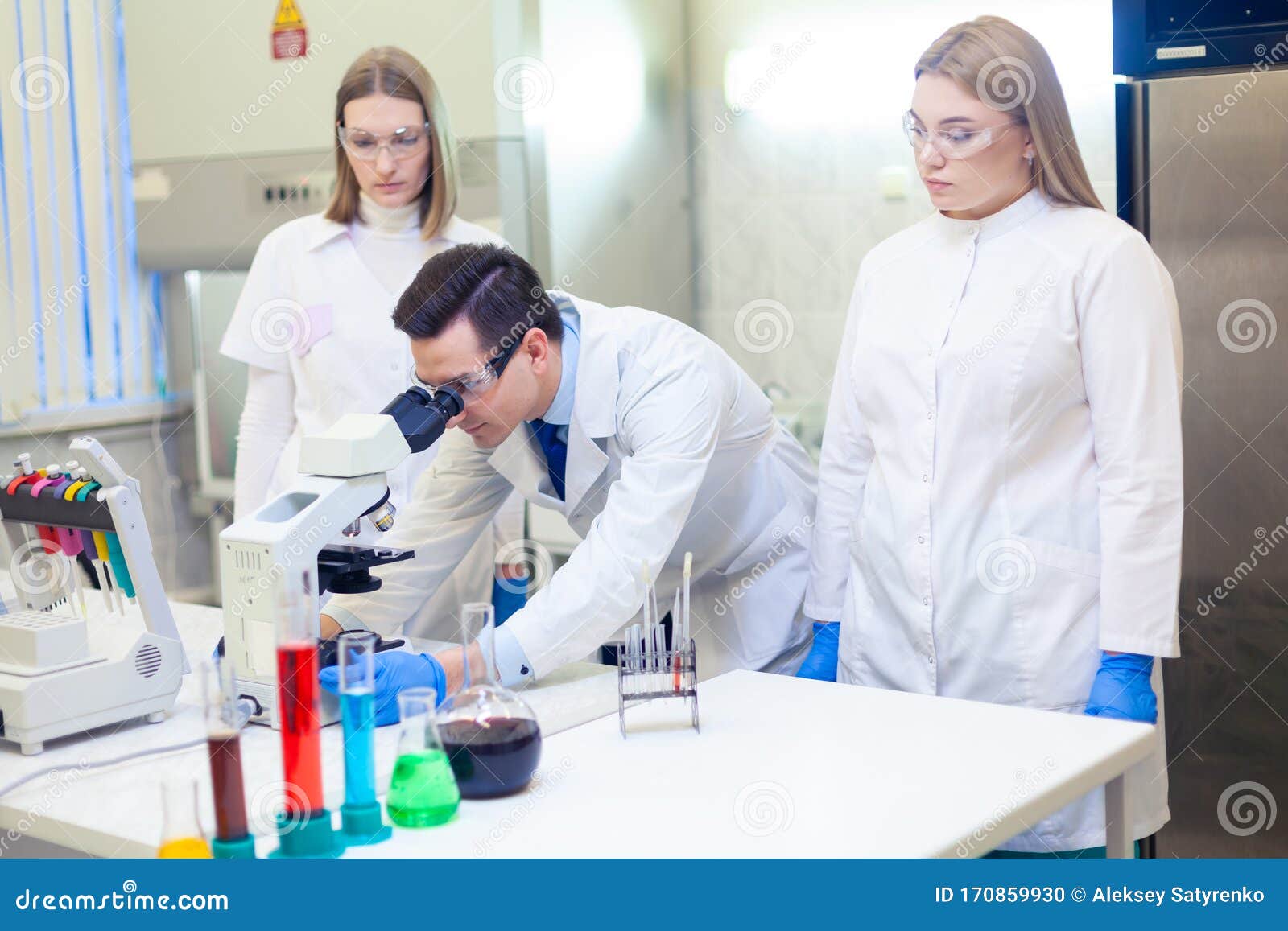 A Group of Scientists Conducts Research in a Scientific Laboratory ...