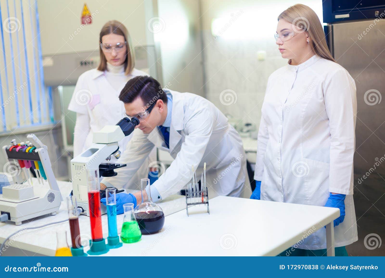 A Group of Scientists Conducts Research in a Scientific Laboratory ...