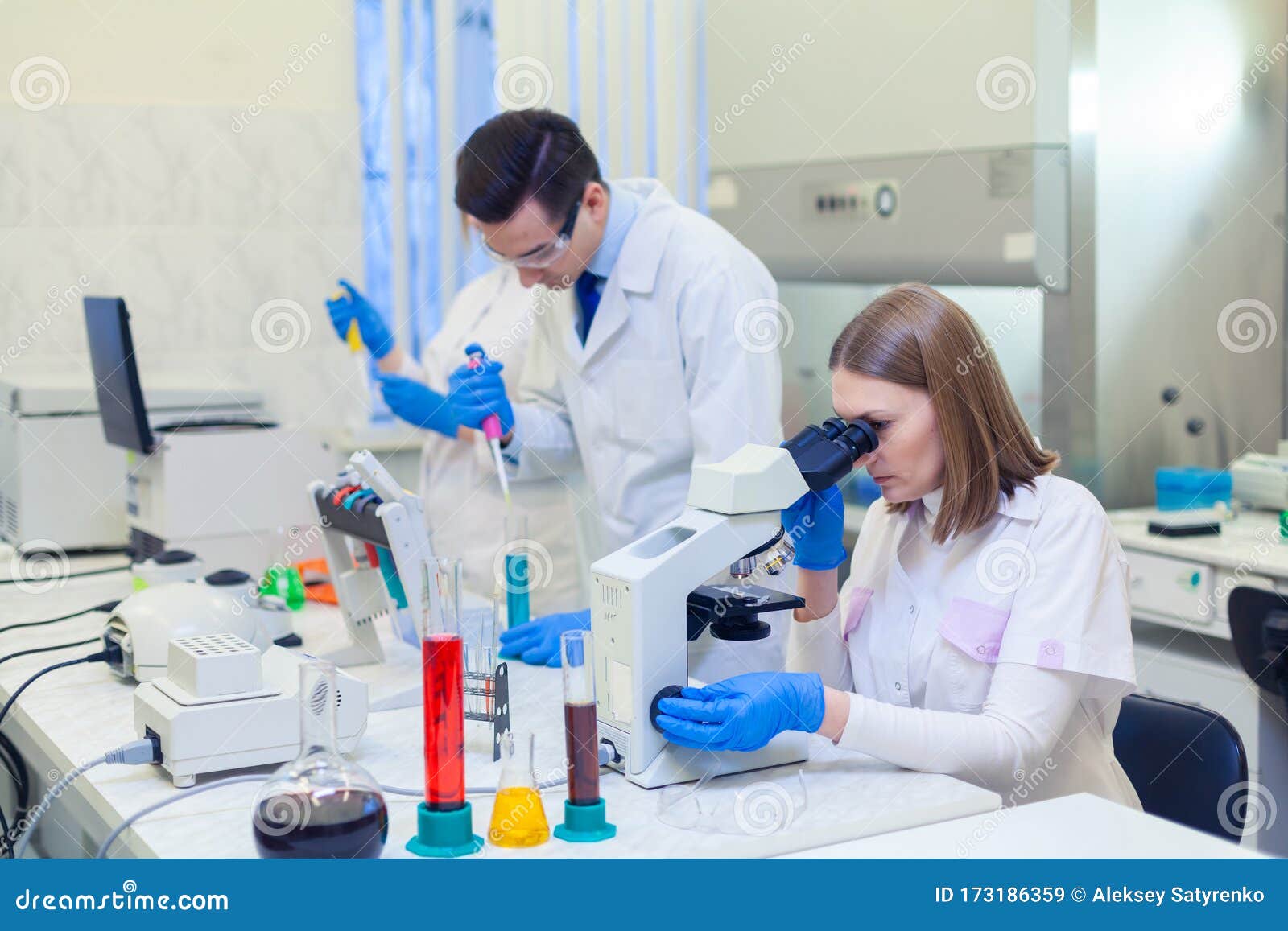 A Group of Scientists Conducts Research in a Scientific Laboratory ...