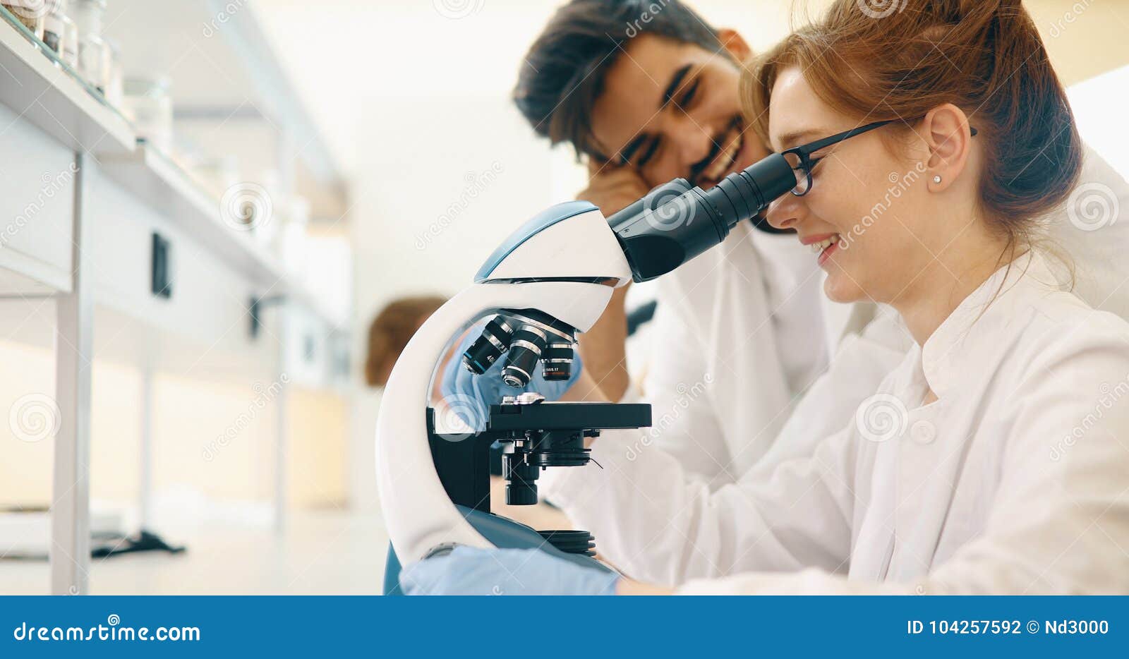 Group of Scientists Doing Research Looking through Microscope Stock ...