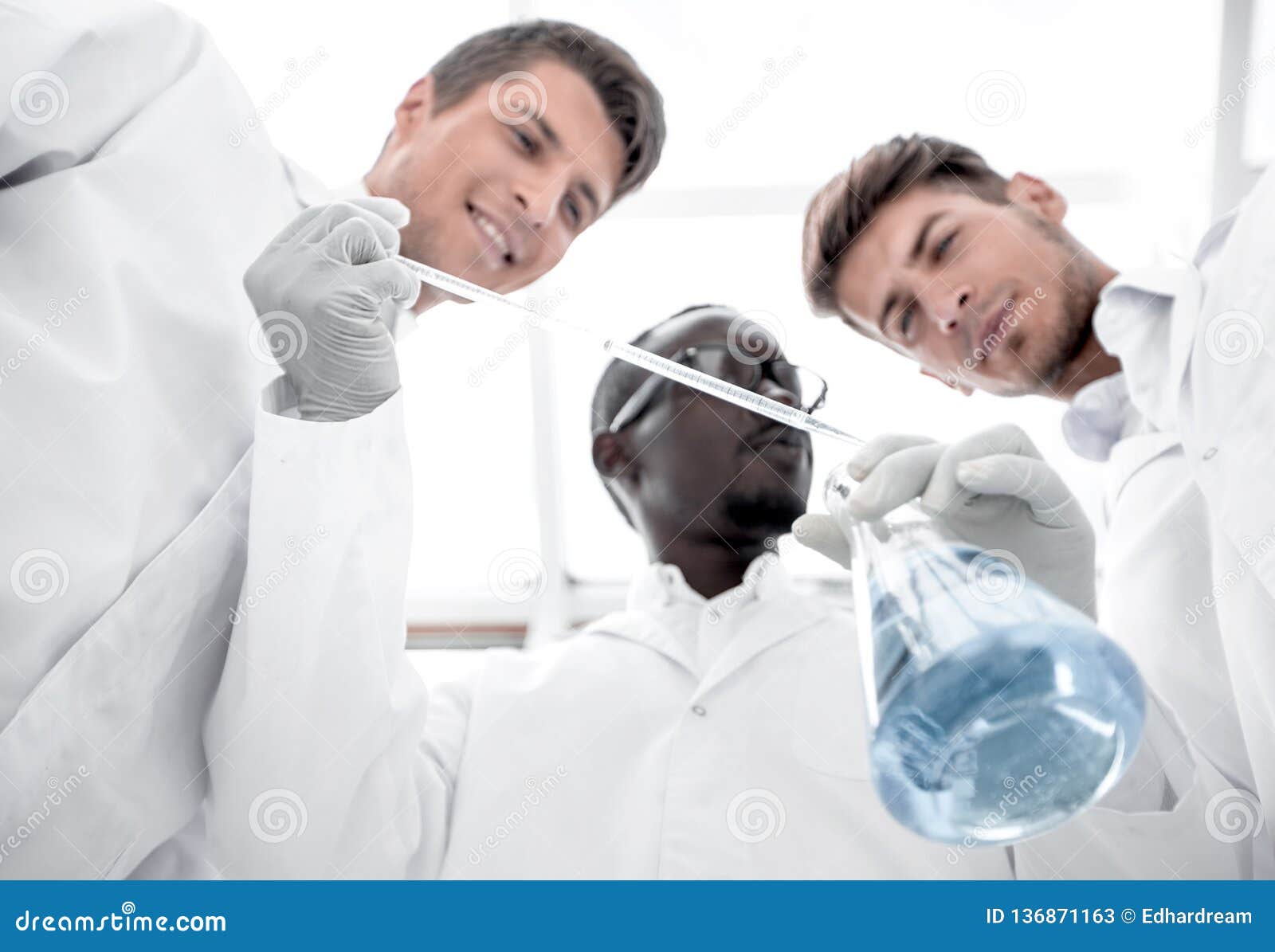 Group of Scientists is Investigating Testing the Liquid in the Flask ...