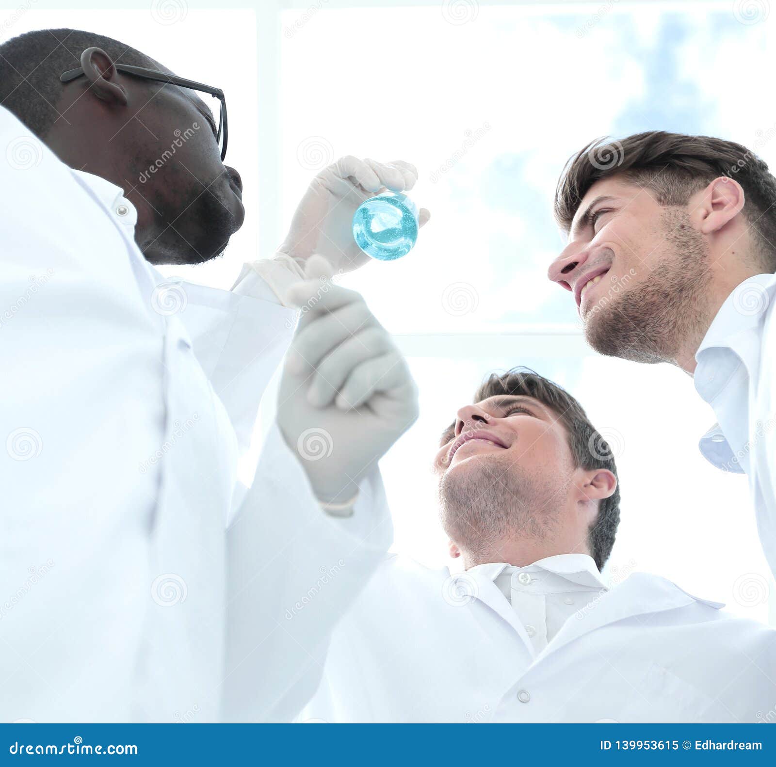 Group of Scientists Looking at the Results of Their Experiment. Stock ...